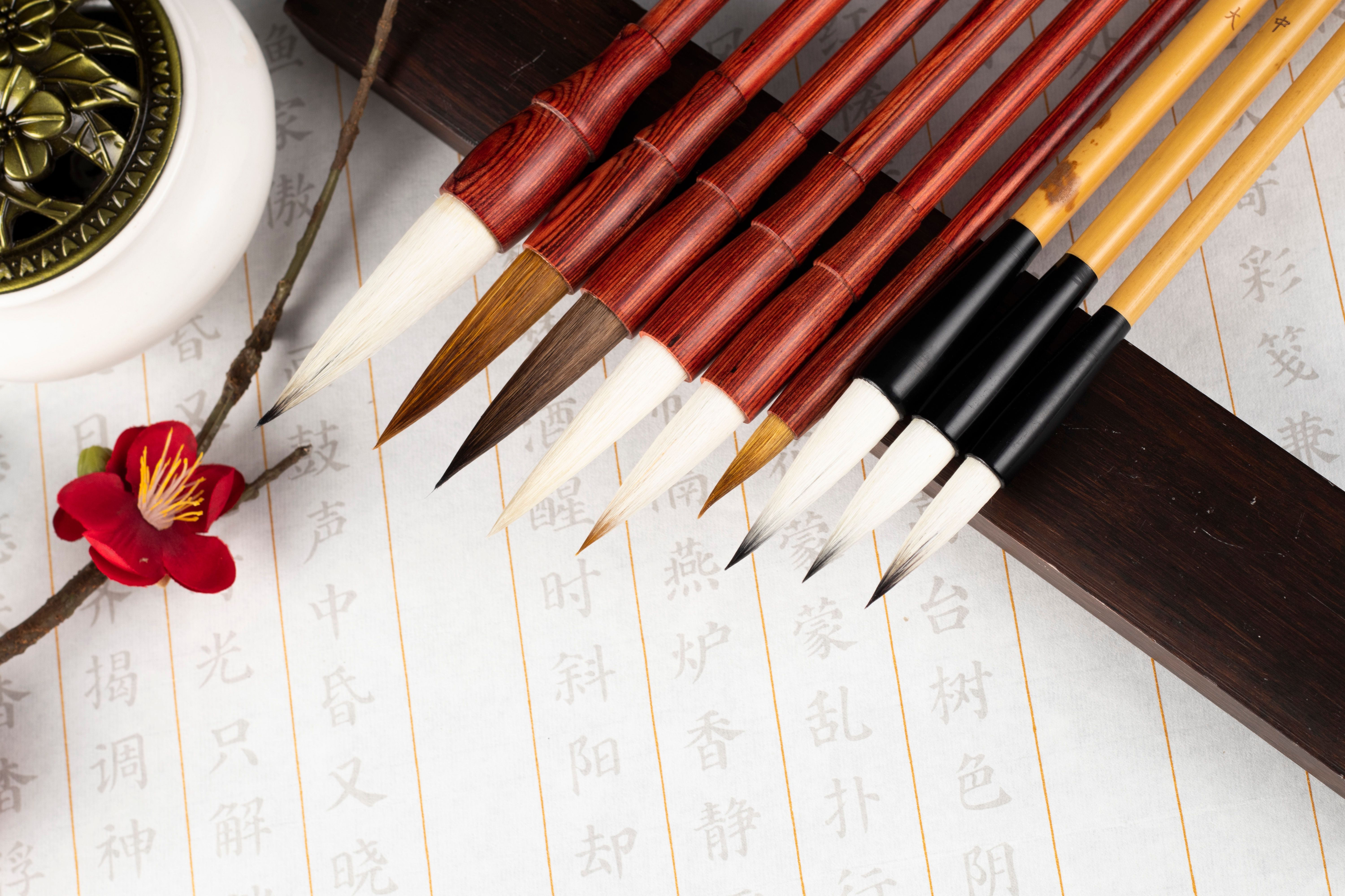 Collection of modern calligraphy brushes on table with decor · Free ...
