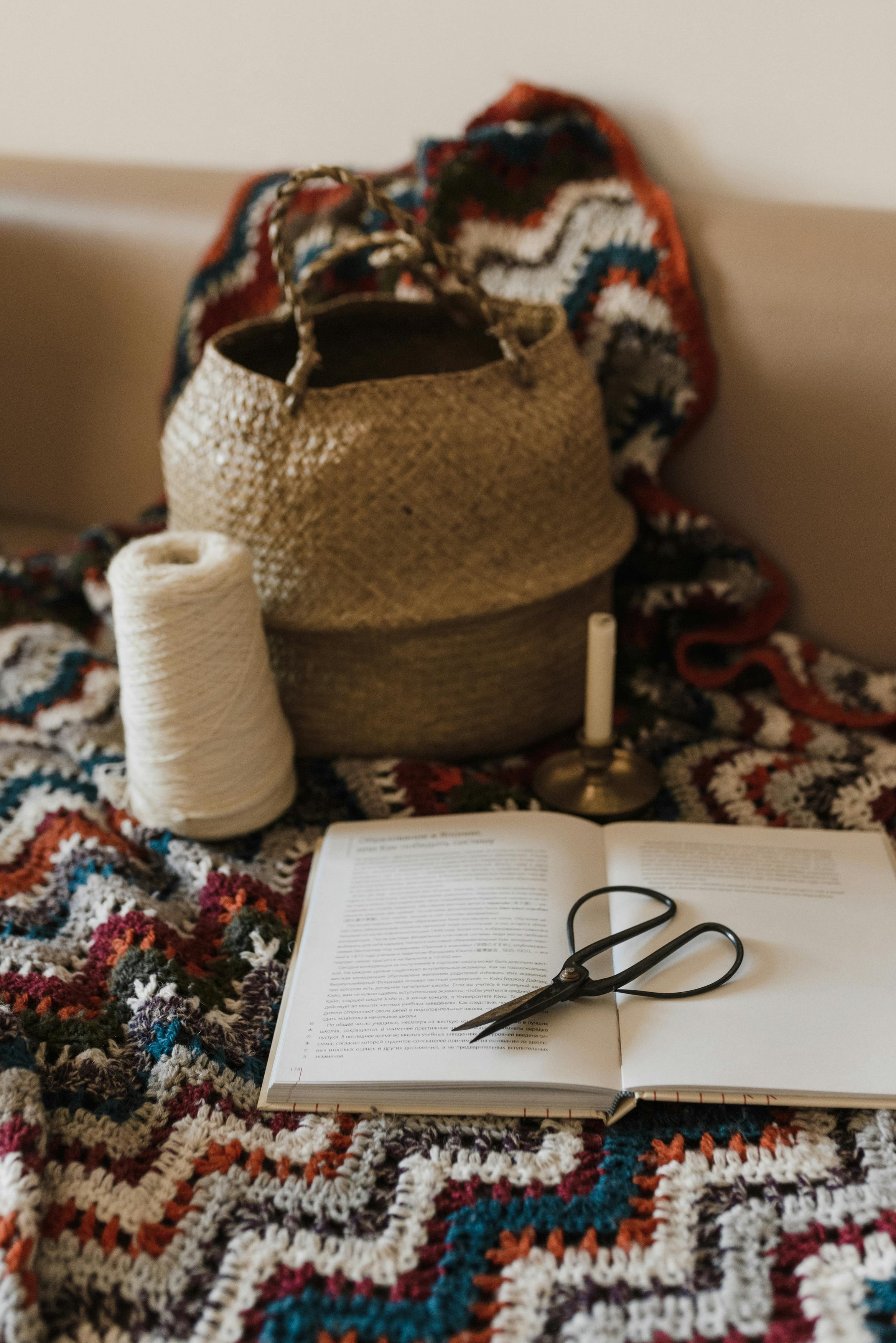 Scissors on an Open Book Beside a Thread · Free Stock Photo