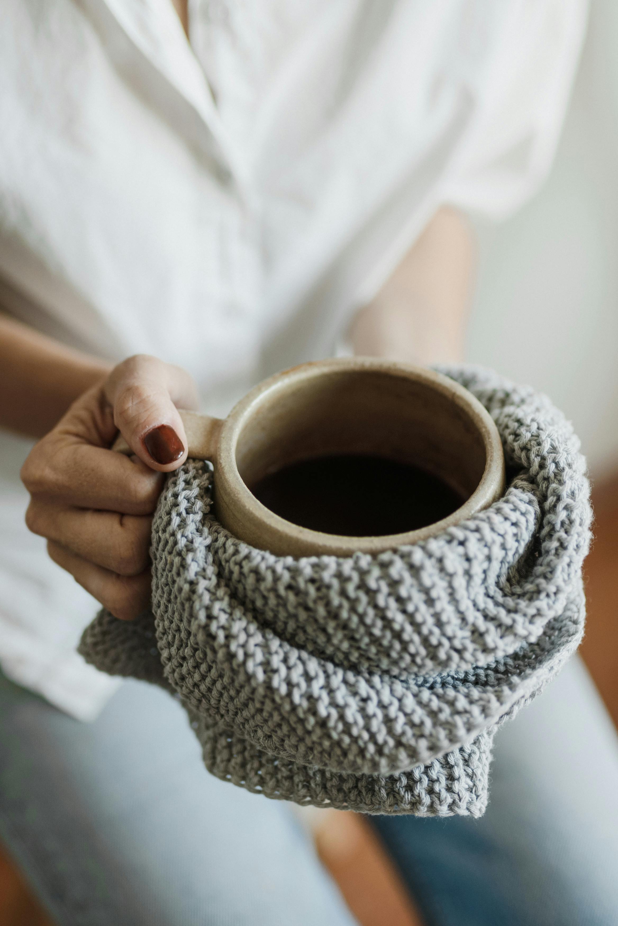 A Person Holding a Ceramic Mug Wrapped with Knitted Cloth · Free Stock ...