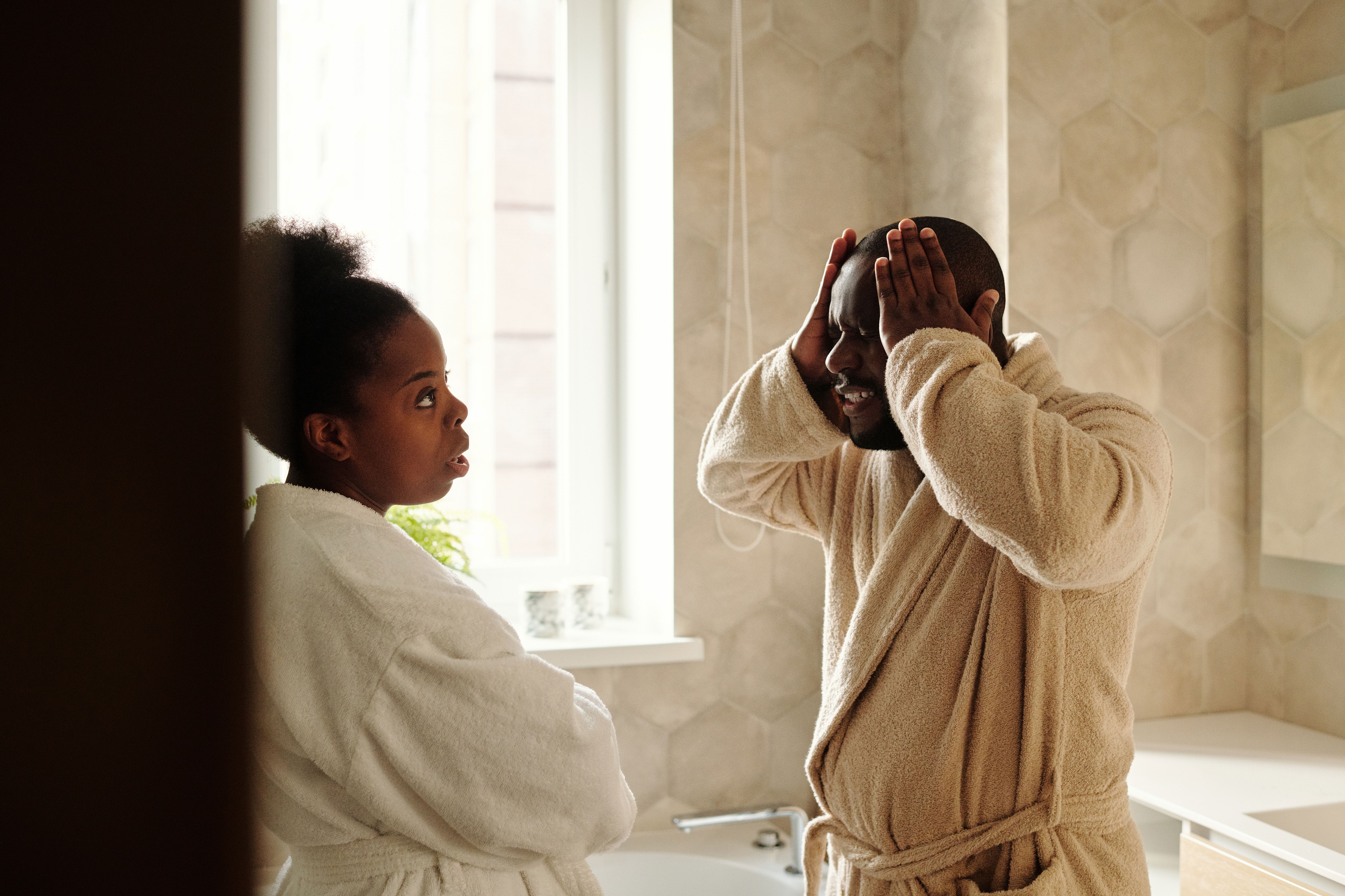 Couple in Robes Arguing · Free Stock Photo