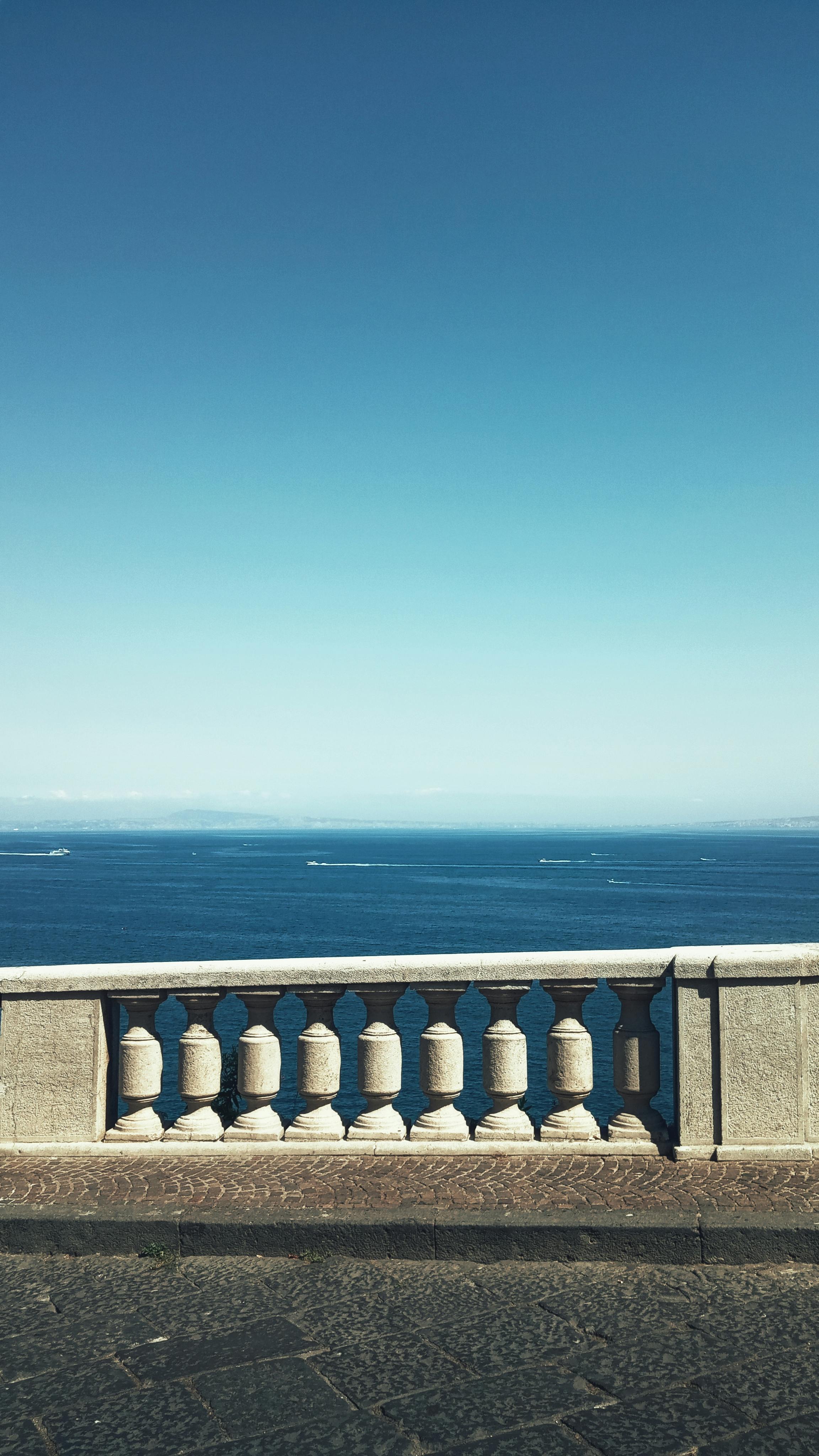 Footpath with wooden railings leading to sea · Free Stock Photo