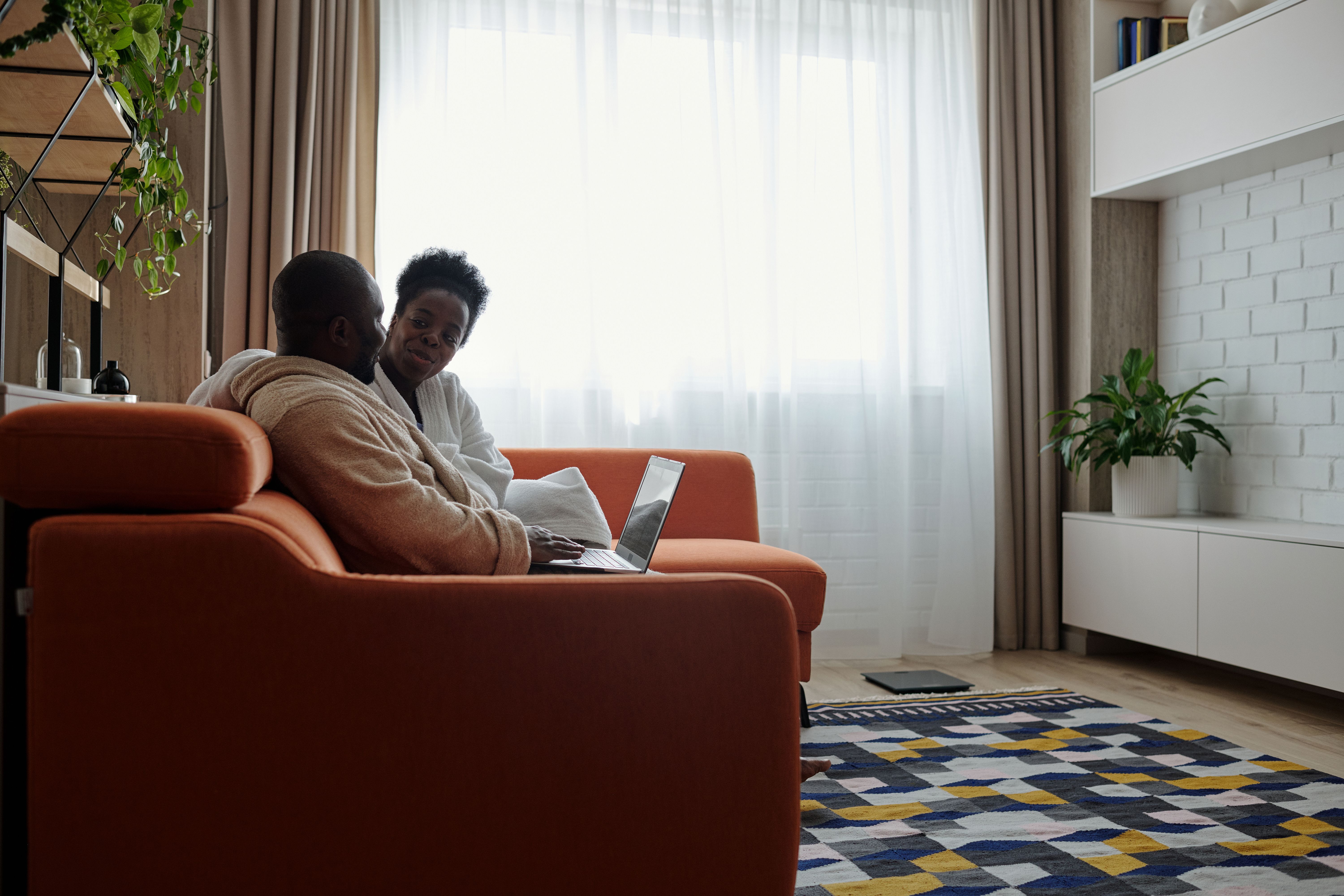 A Couple Talking while Sitting on a Sofa · Free Stock Photo