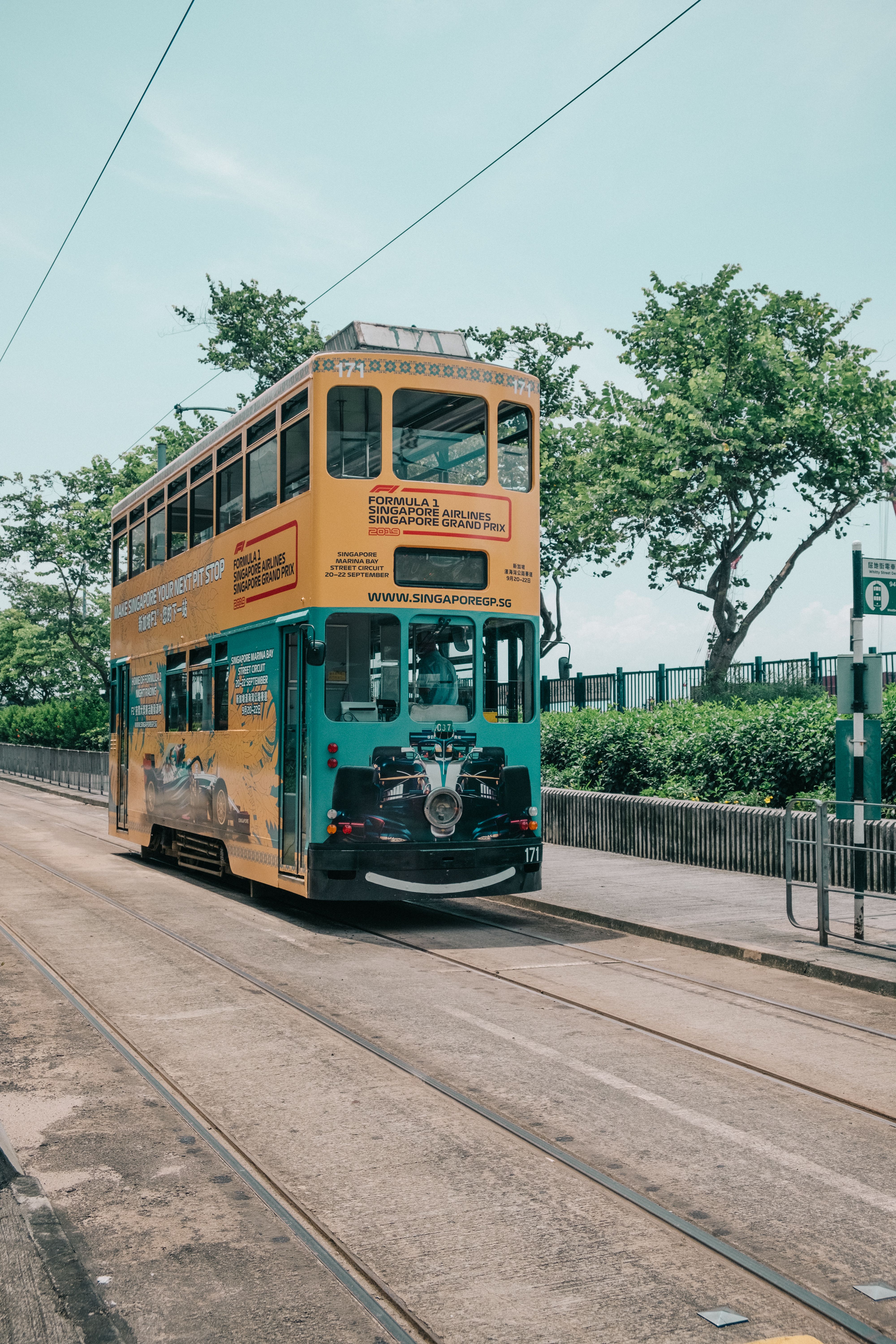 Yellow and Green Tram on Road · Free Stock Photo