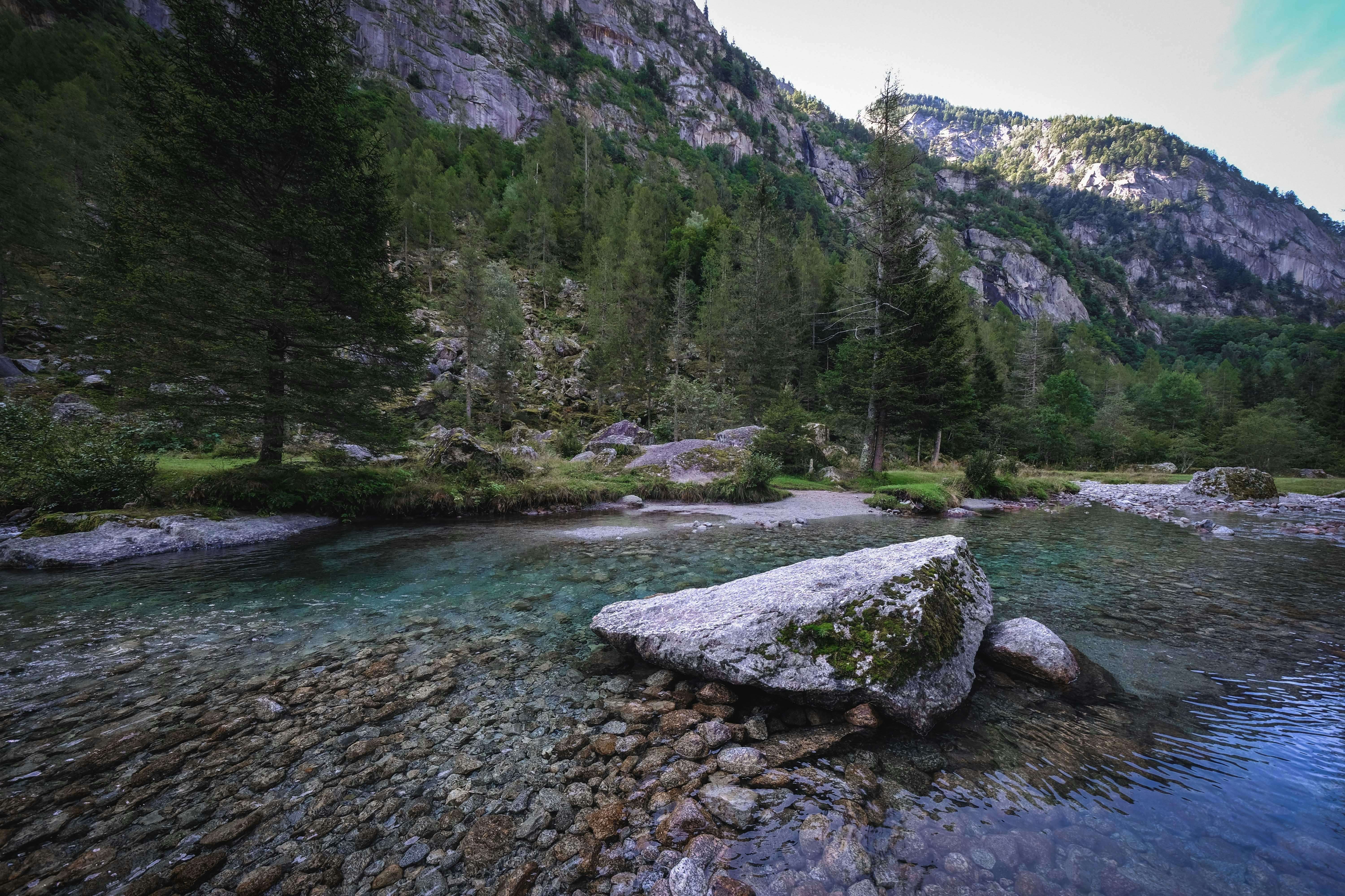 Scenic landscape of rocky cliffs surrounding lake at sunset · Free ...