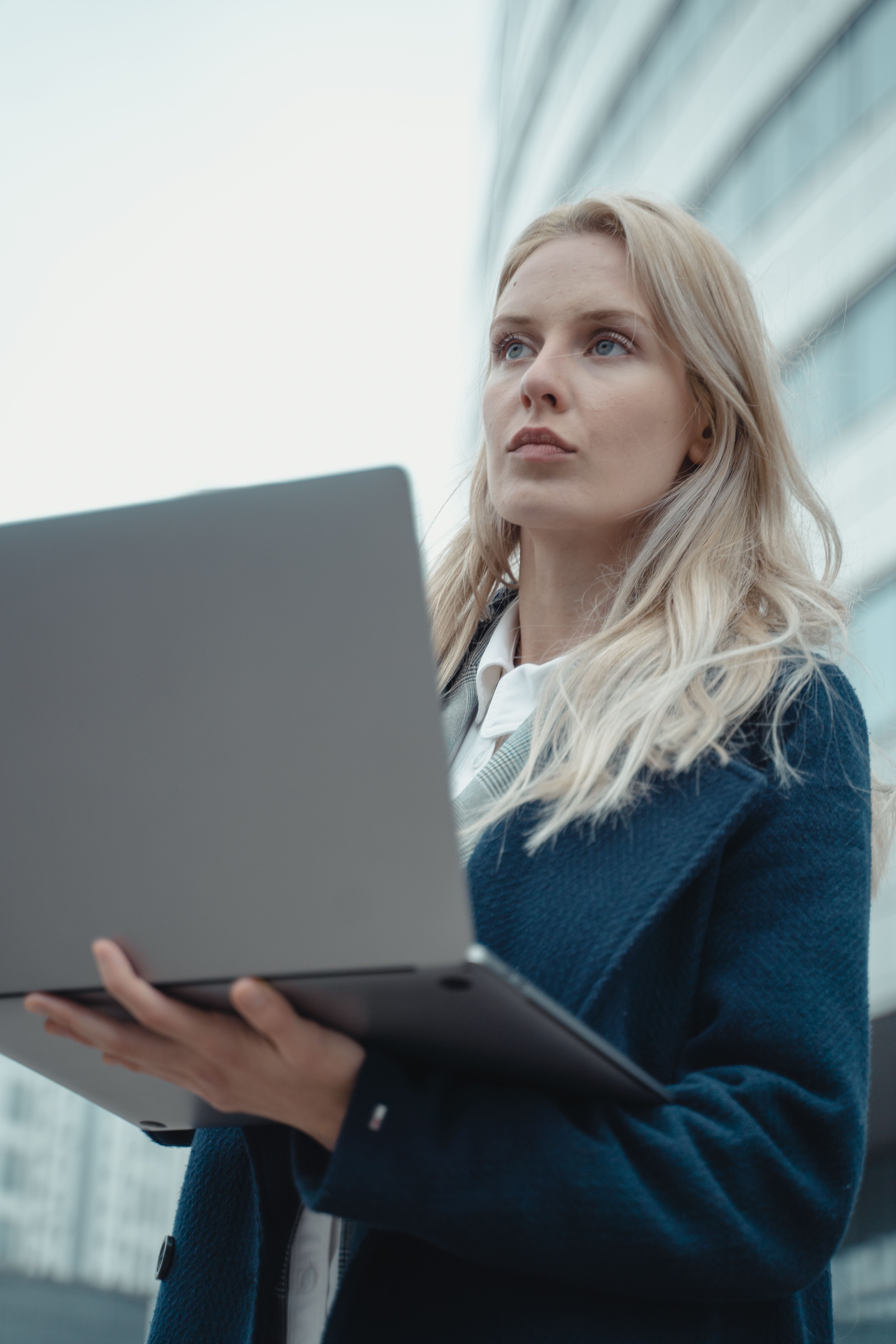 Woman Standing While Holding Her Laptop Computer · Free Stock Photo
