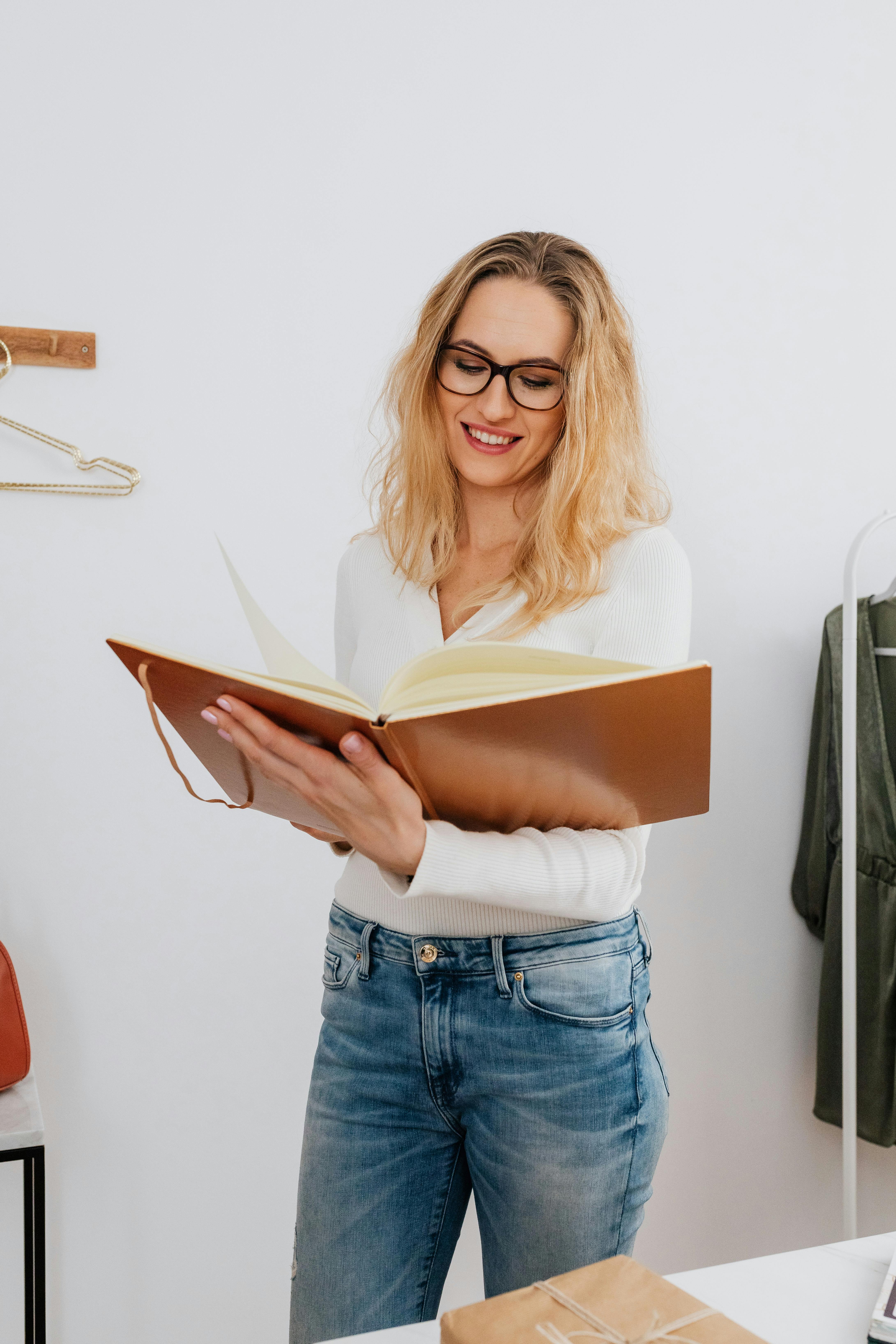 Pretty woman Wearing a Robe Holding Books · Free Stock Photo