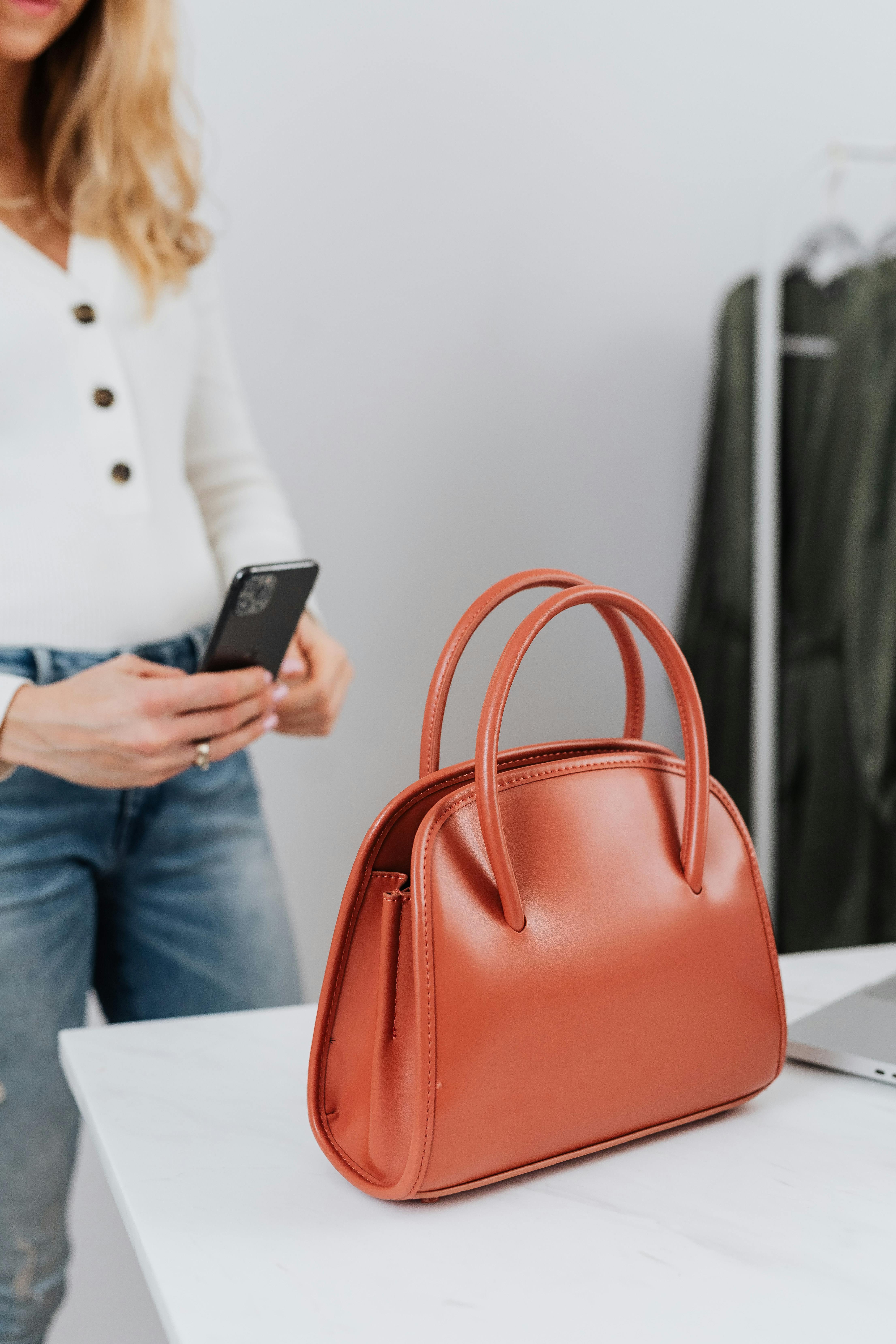 Person Taking a Picture of a Leather Bag · Free Stock Photo