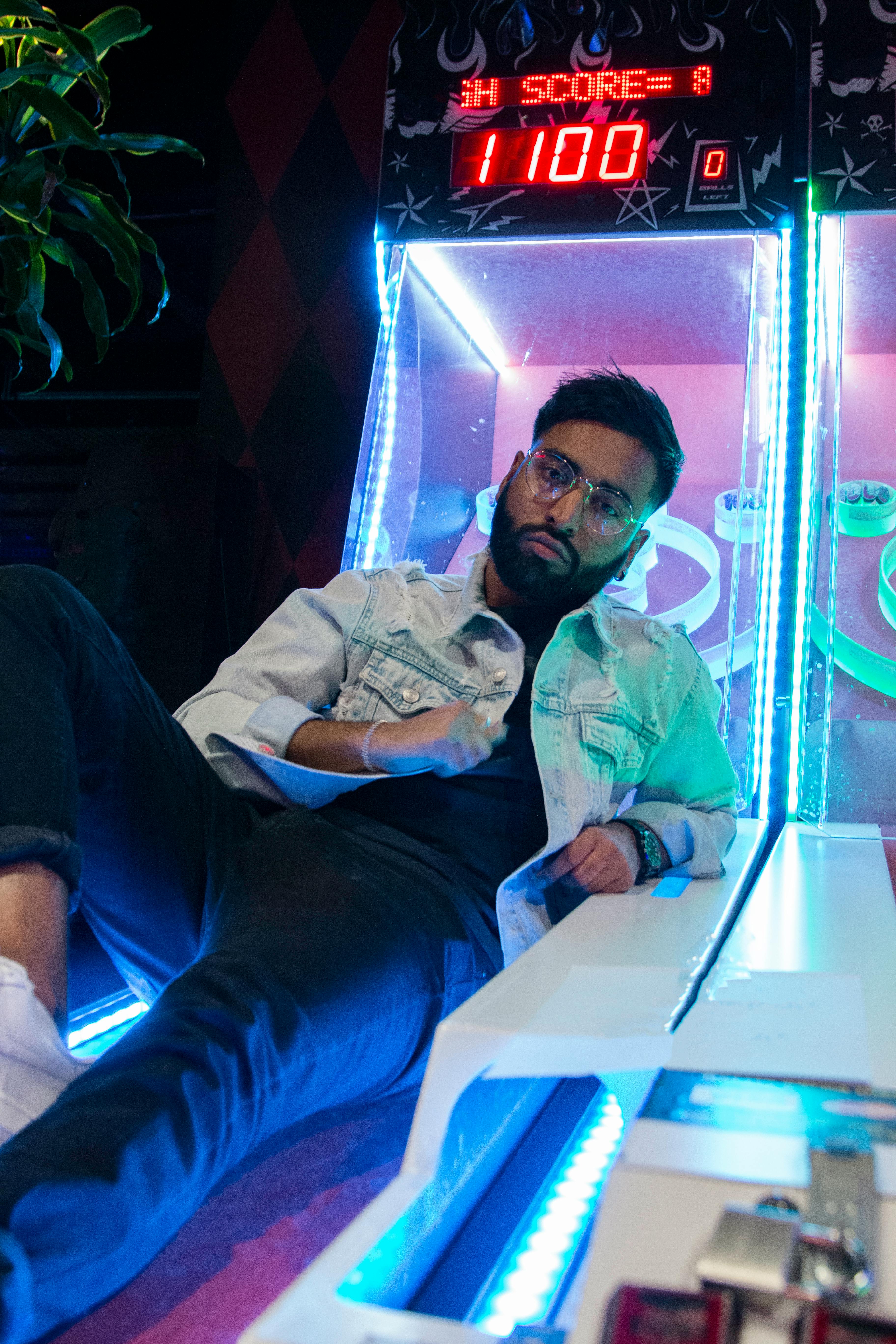 Man Lying on the Arcade Game Machine while Looking at the Camera · Free ...