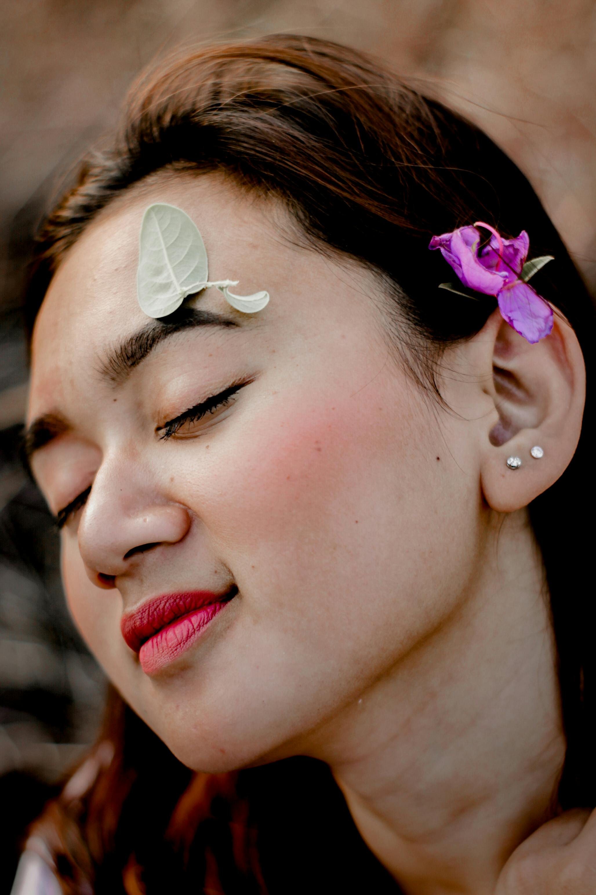 A Woman with Pink Flower Petals and Green Leaves on Her Face · Free ...