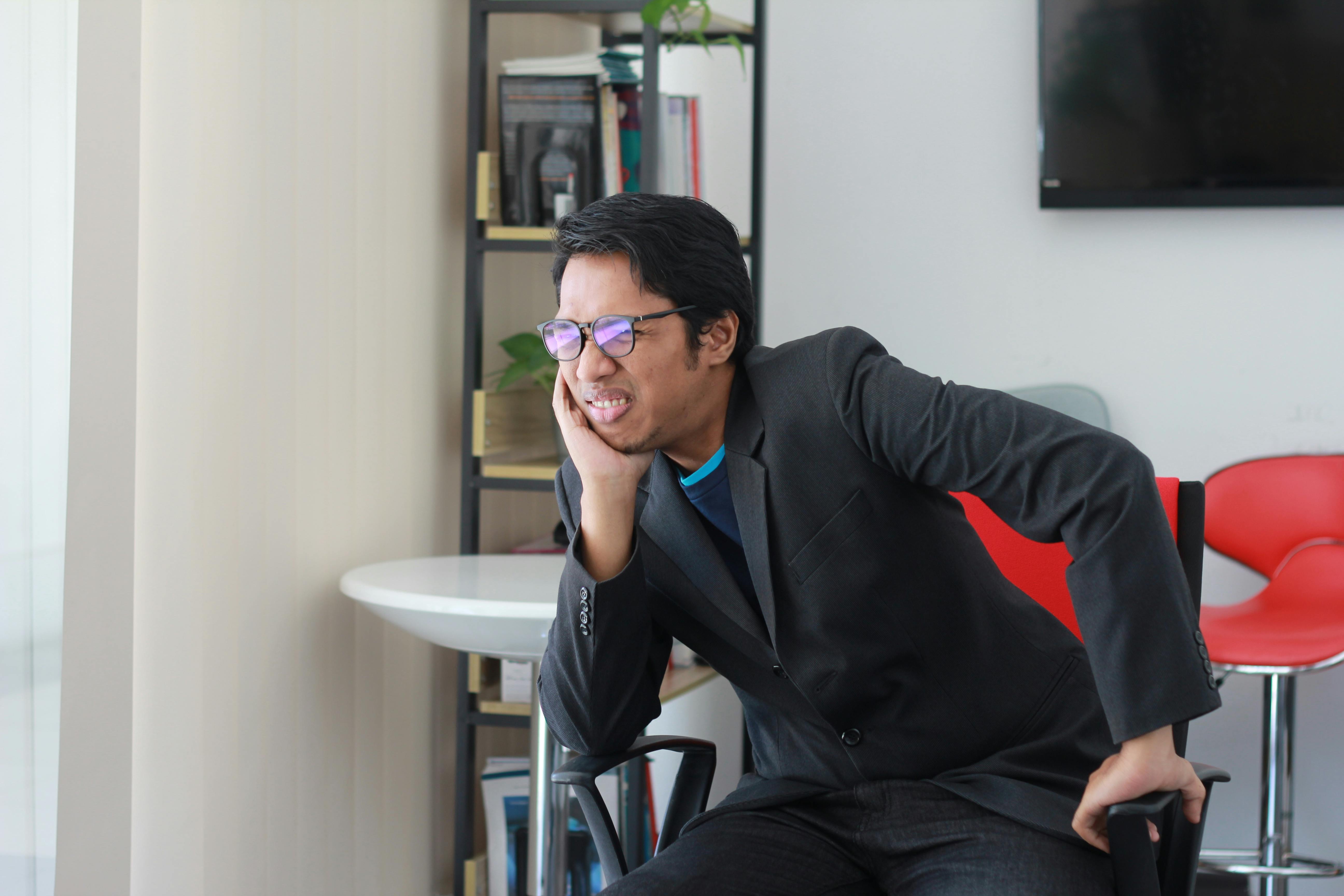 A Man in Black Suit Sitting inside the Office · Free Stock Photo