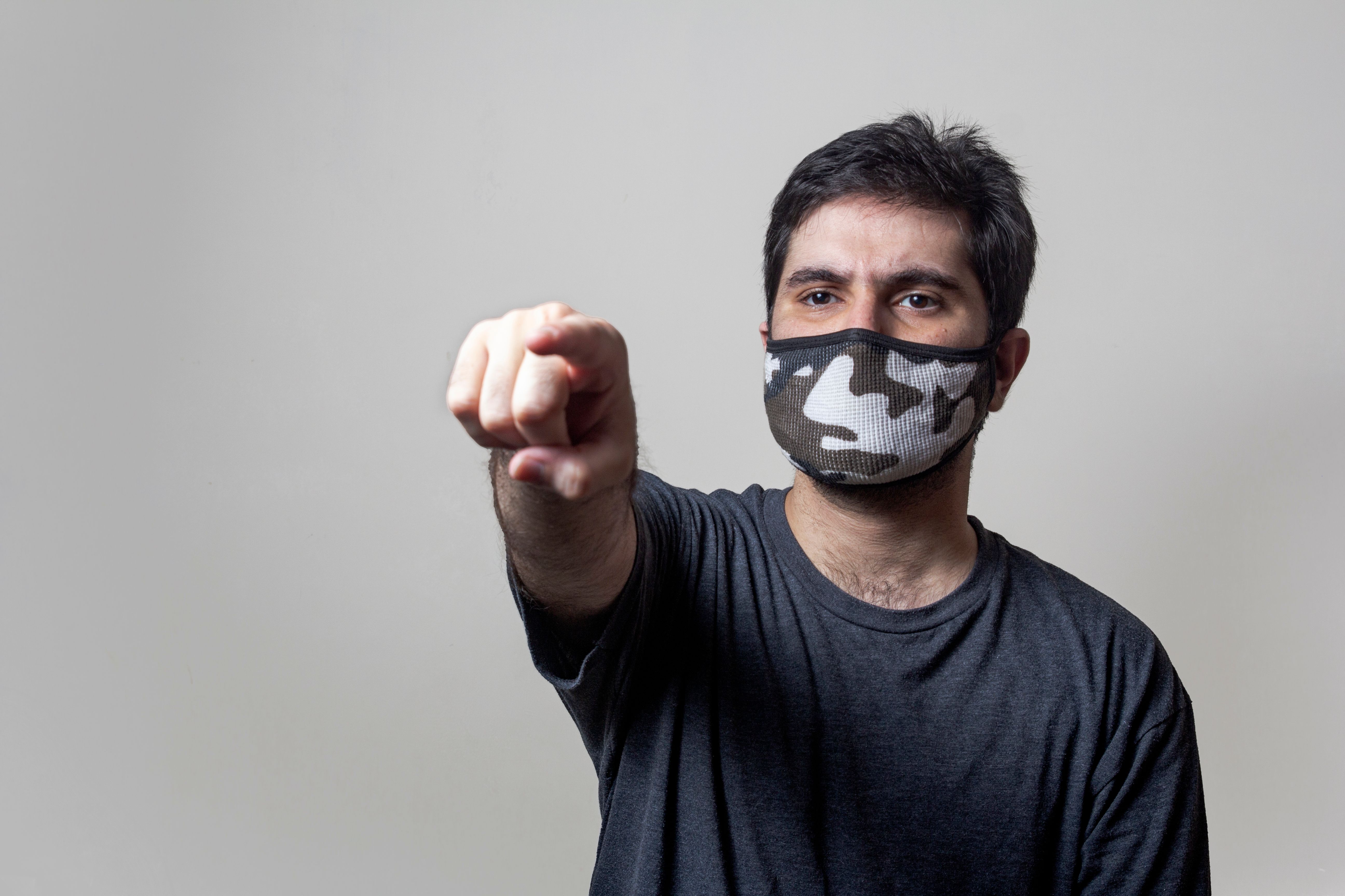Man in Face Mask Pointing with Finger · Free Stock Photo