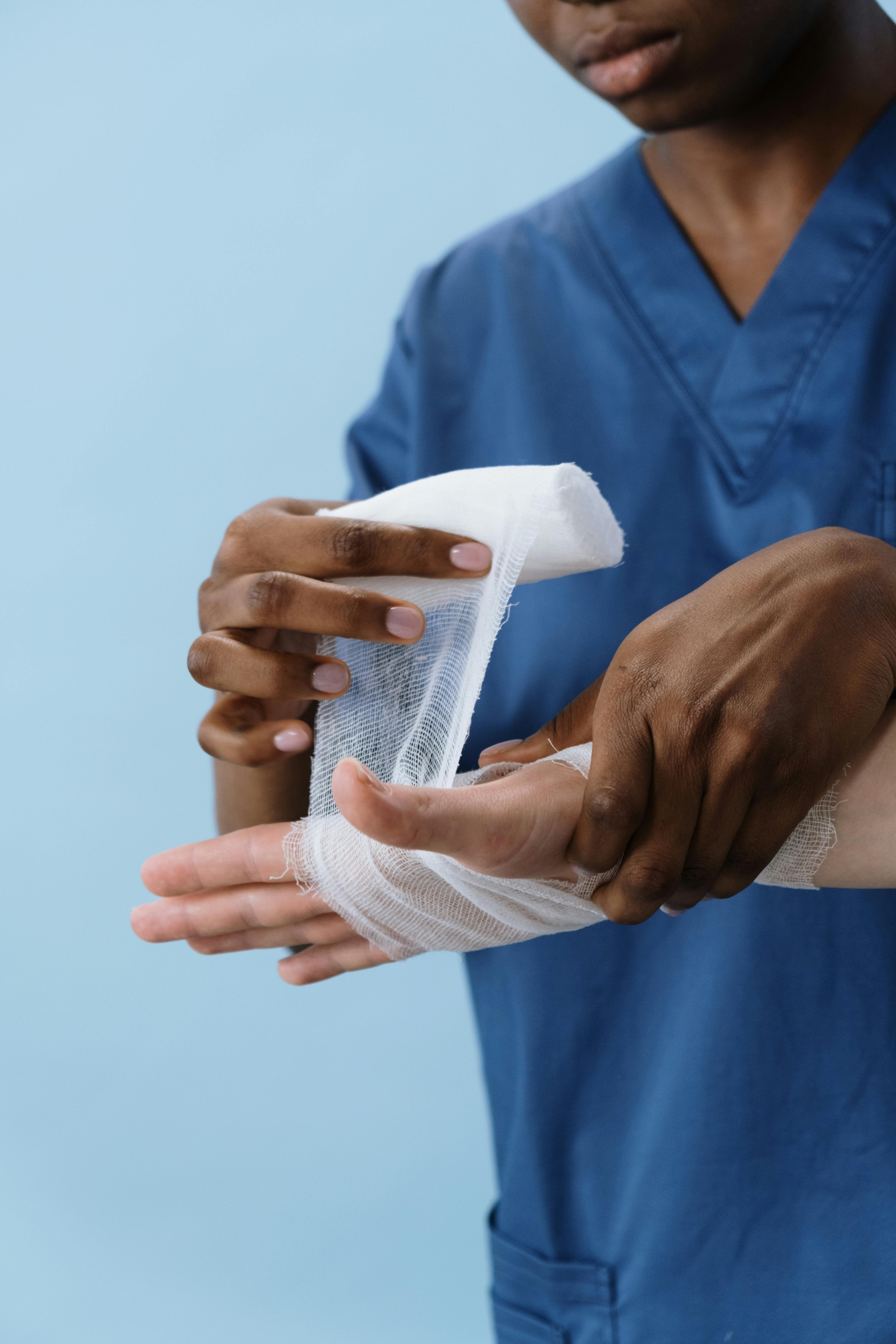 A Person Getting his Hand Bandaged · Free Stock Photo
