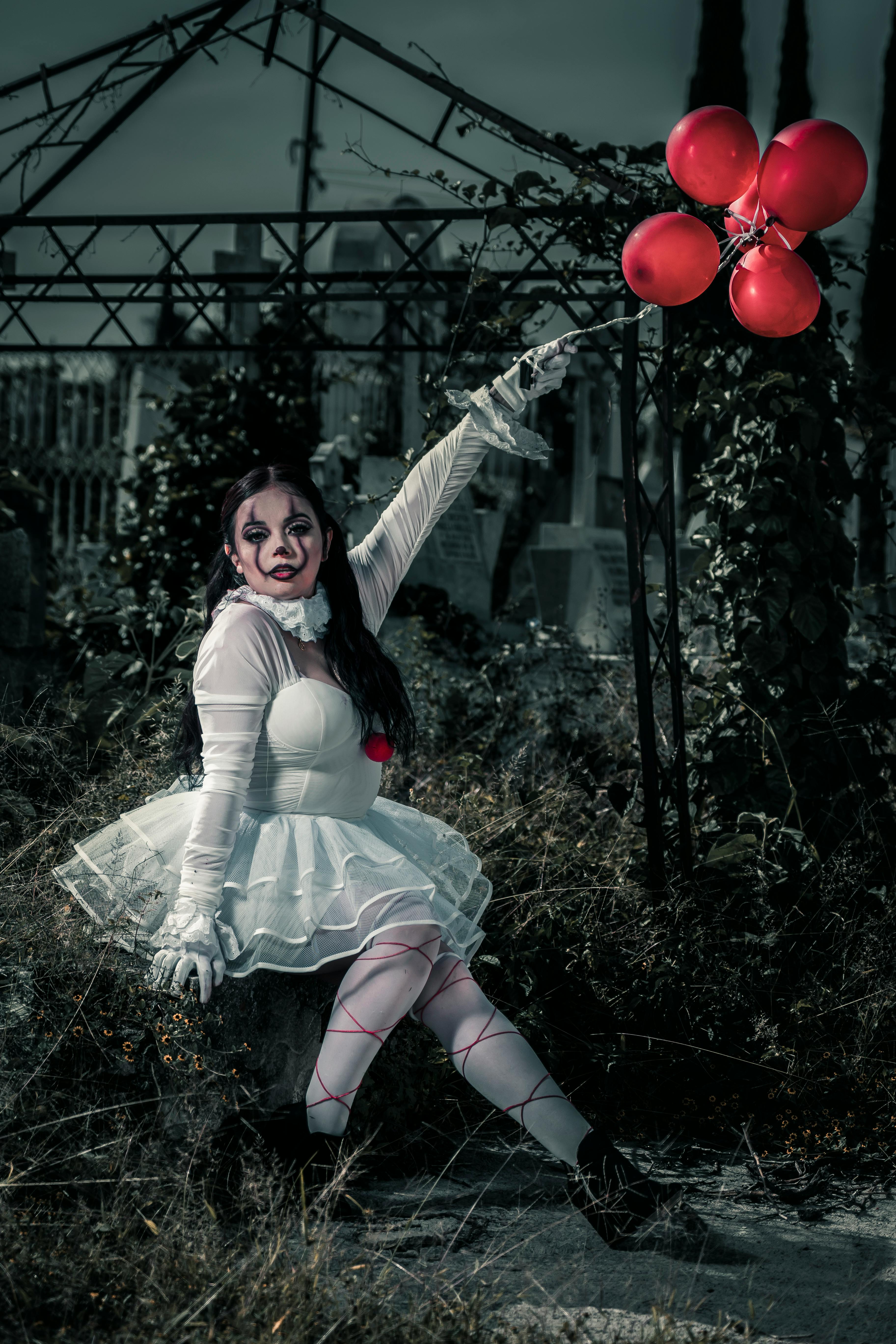 Scary Woman in White Dress Holding Red Balloons · Free Stock Photo