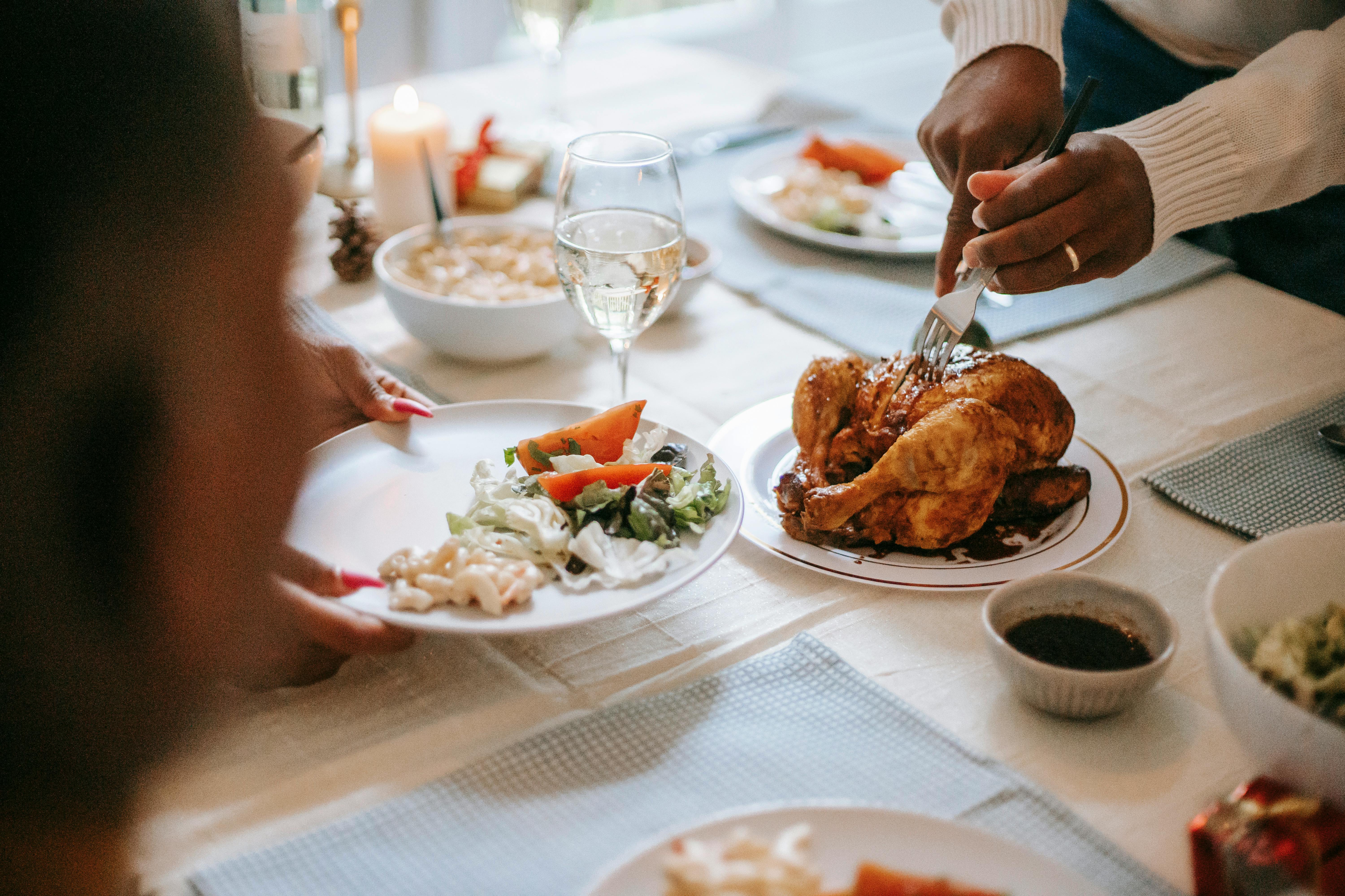 Cutting Chicken during Dinner · Free Stock Photo