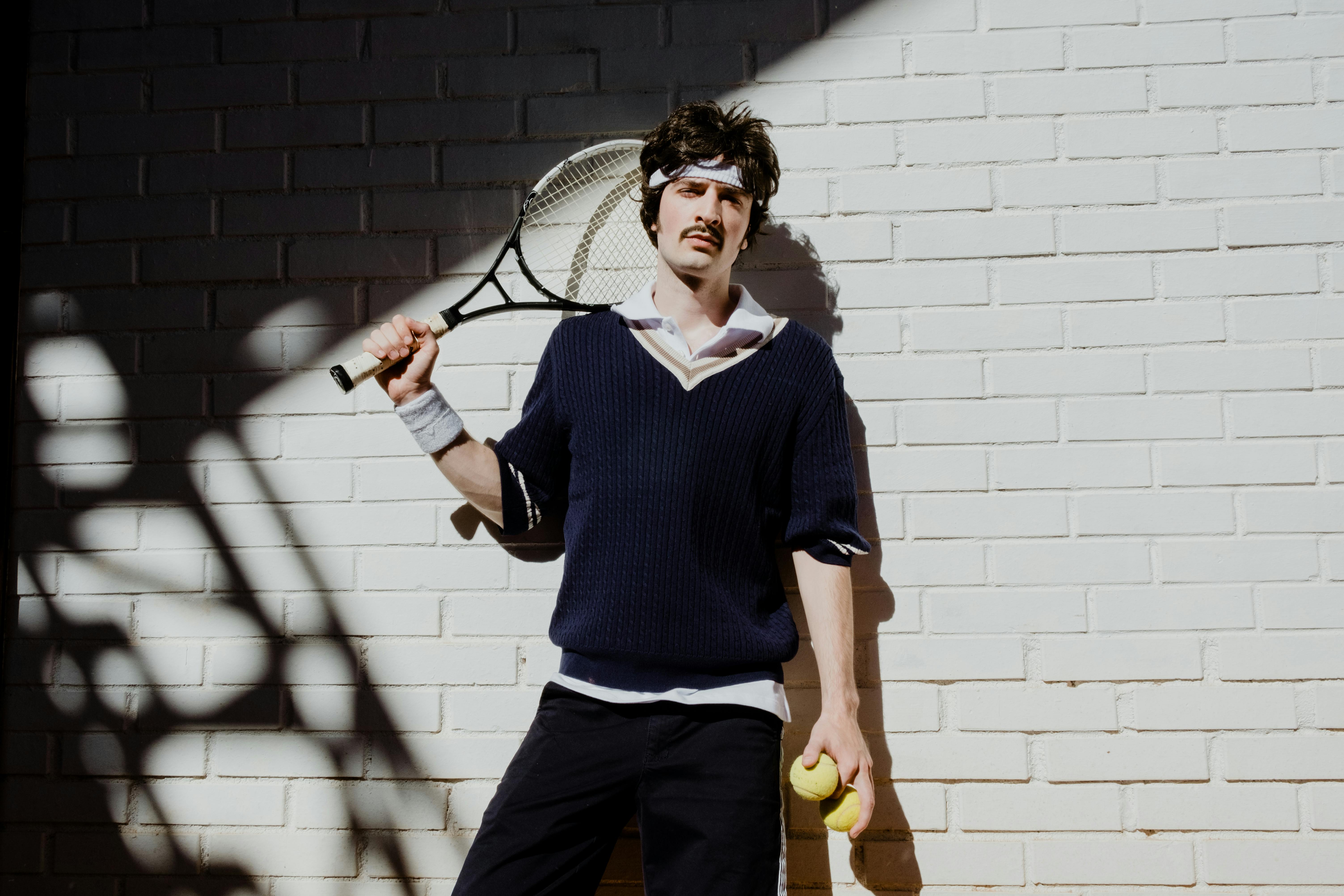 A Man Holding a Tennis Racket · Free Stock Photo