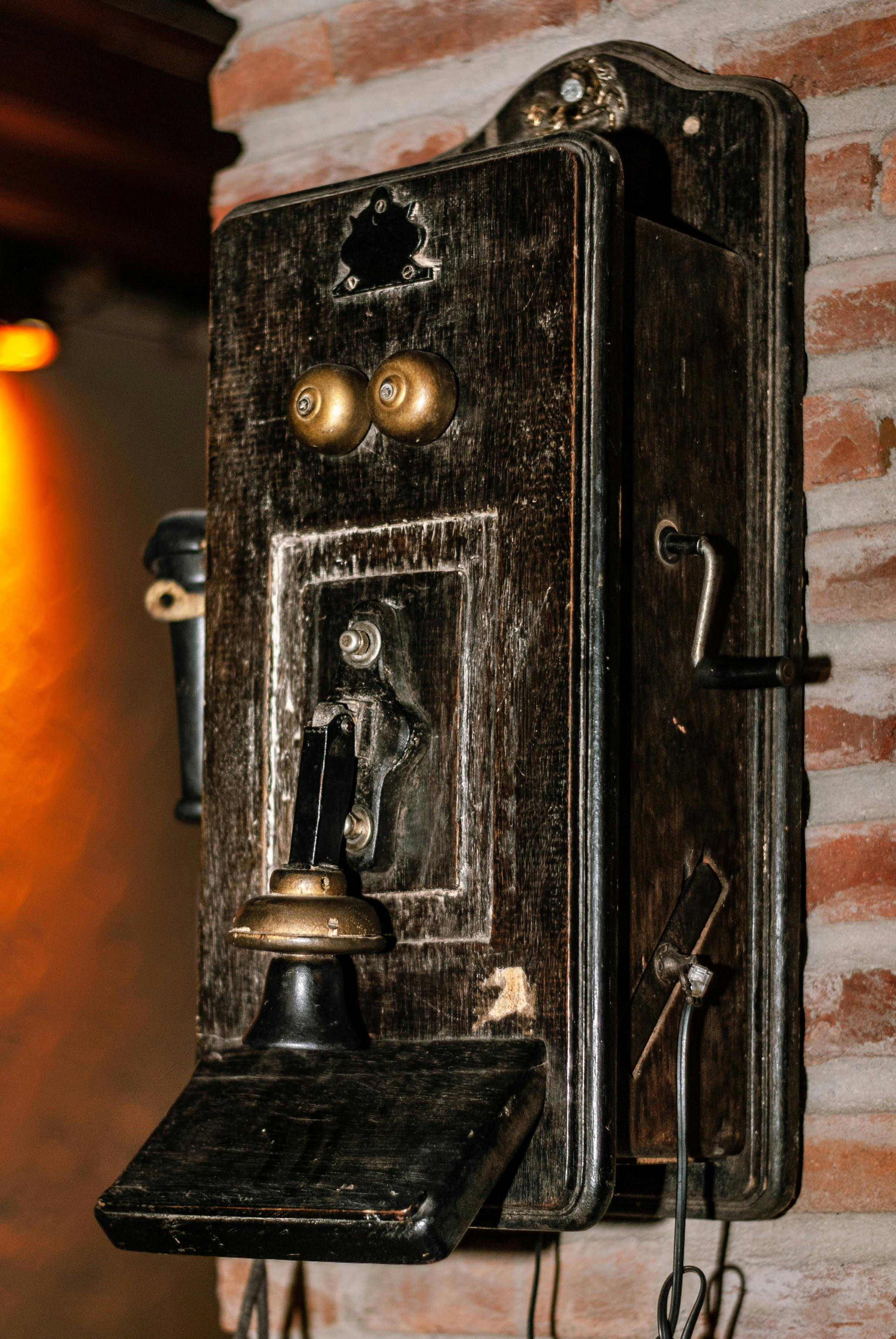 Old metal public payphone hanging on shabby wall · Free Stock Photo