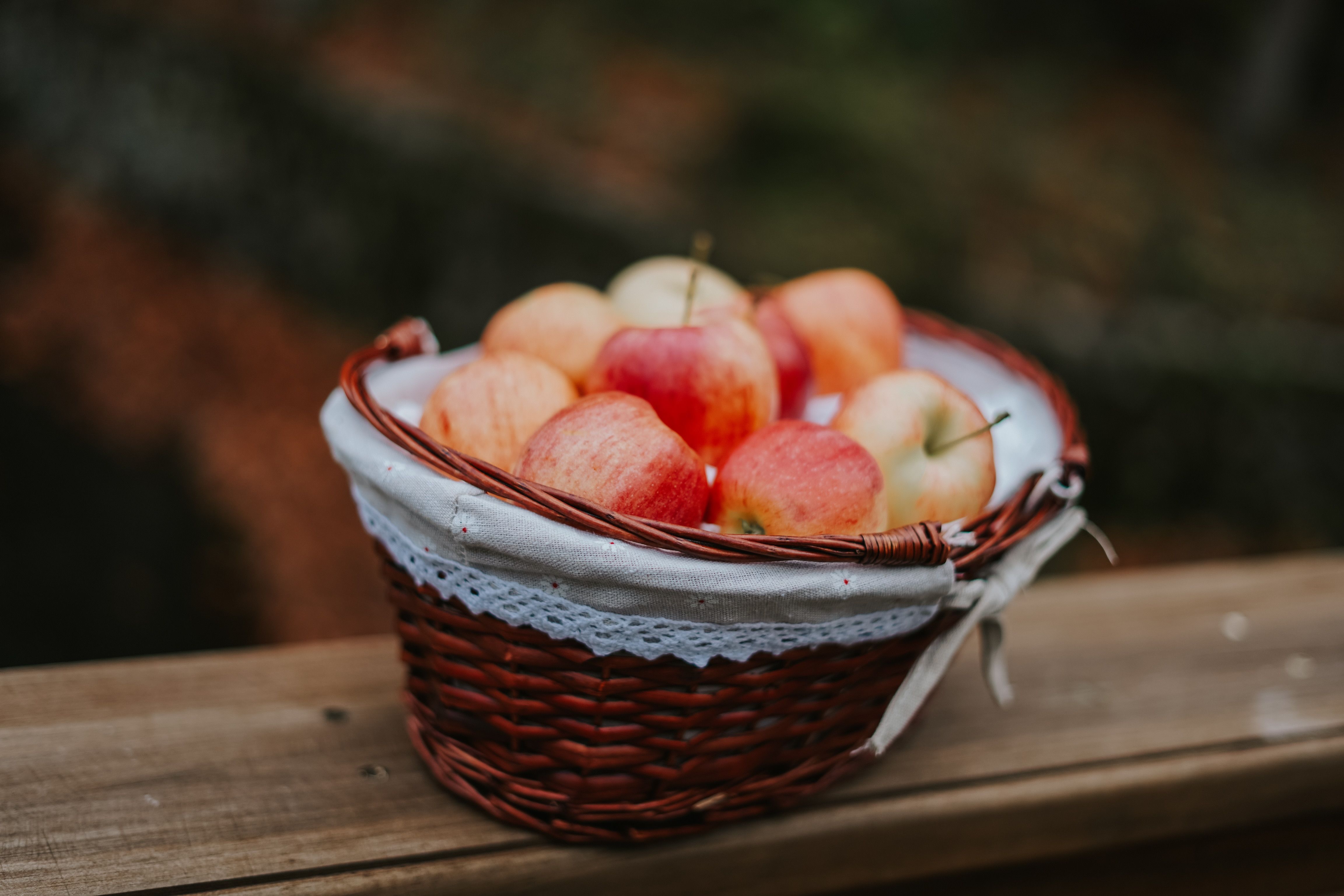 Person Carrying a Basket Full of Apples · Free Stock Photo