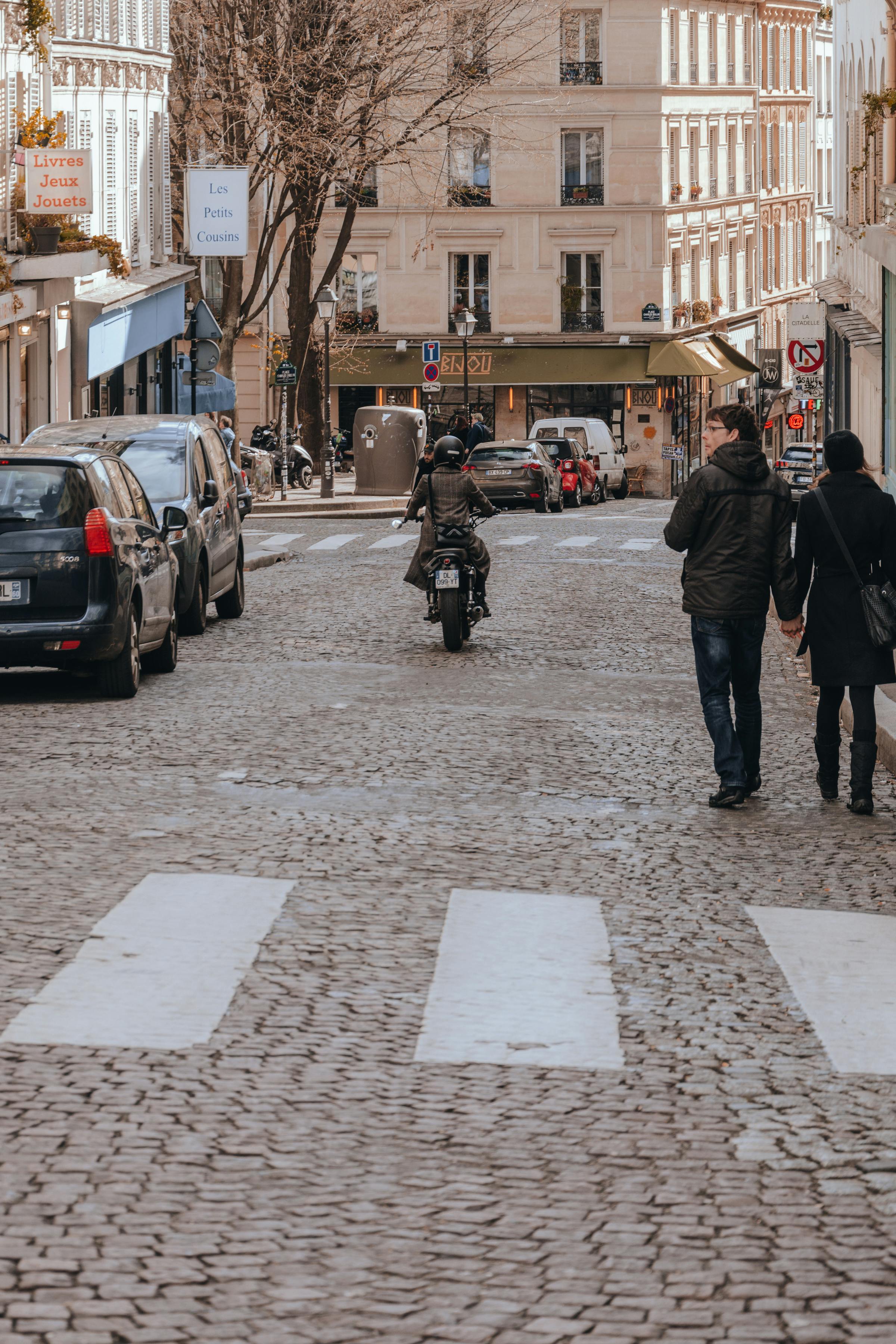 People walking along narrow road · Free Stock Photo