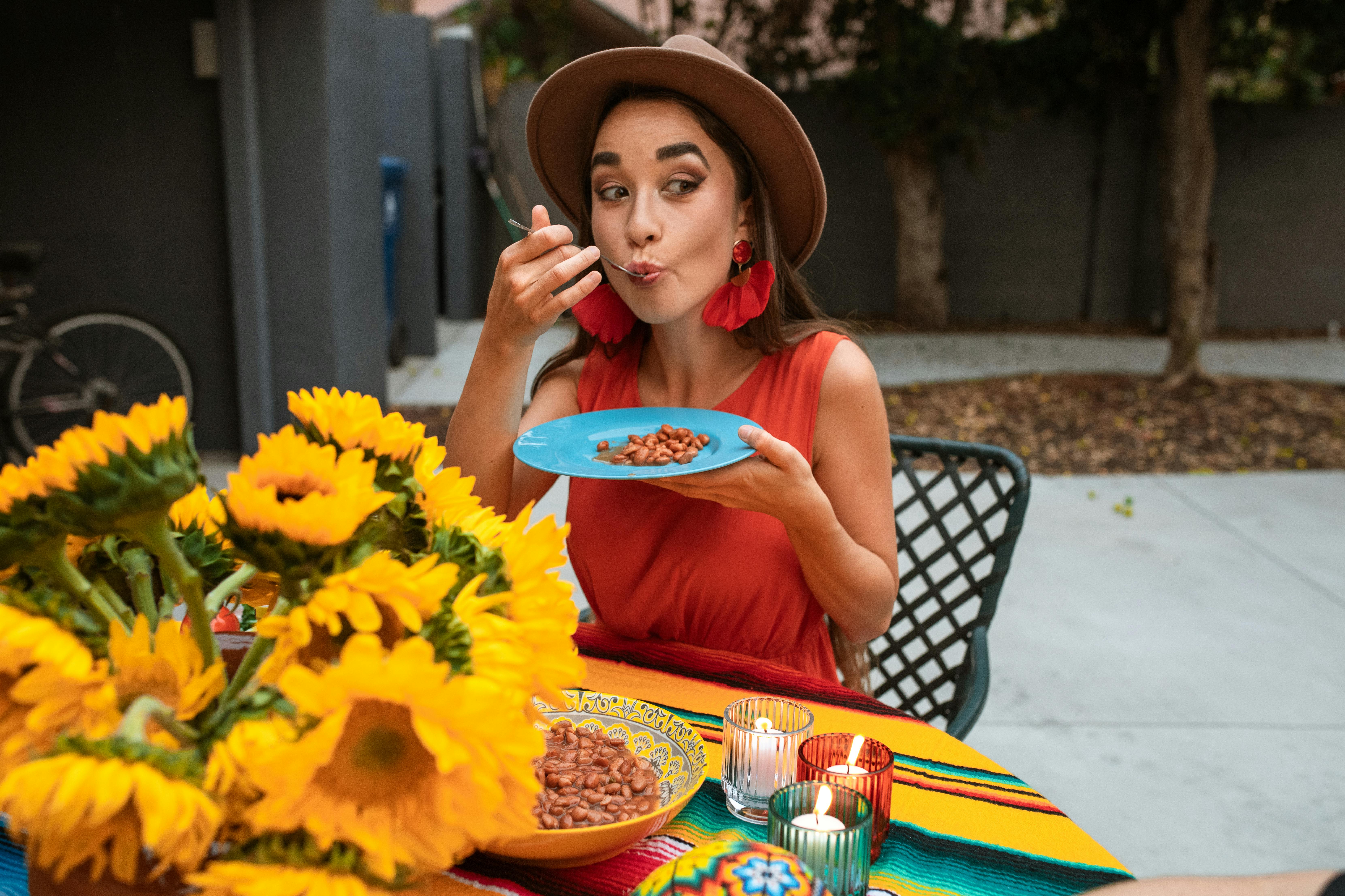 Woman Wearing Red Dress Eating Beans · Free Stock Photo