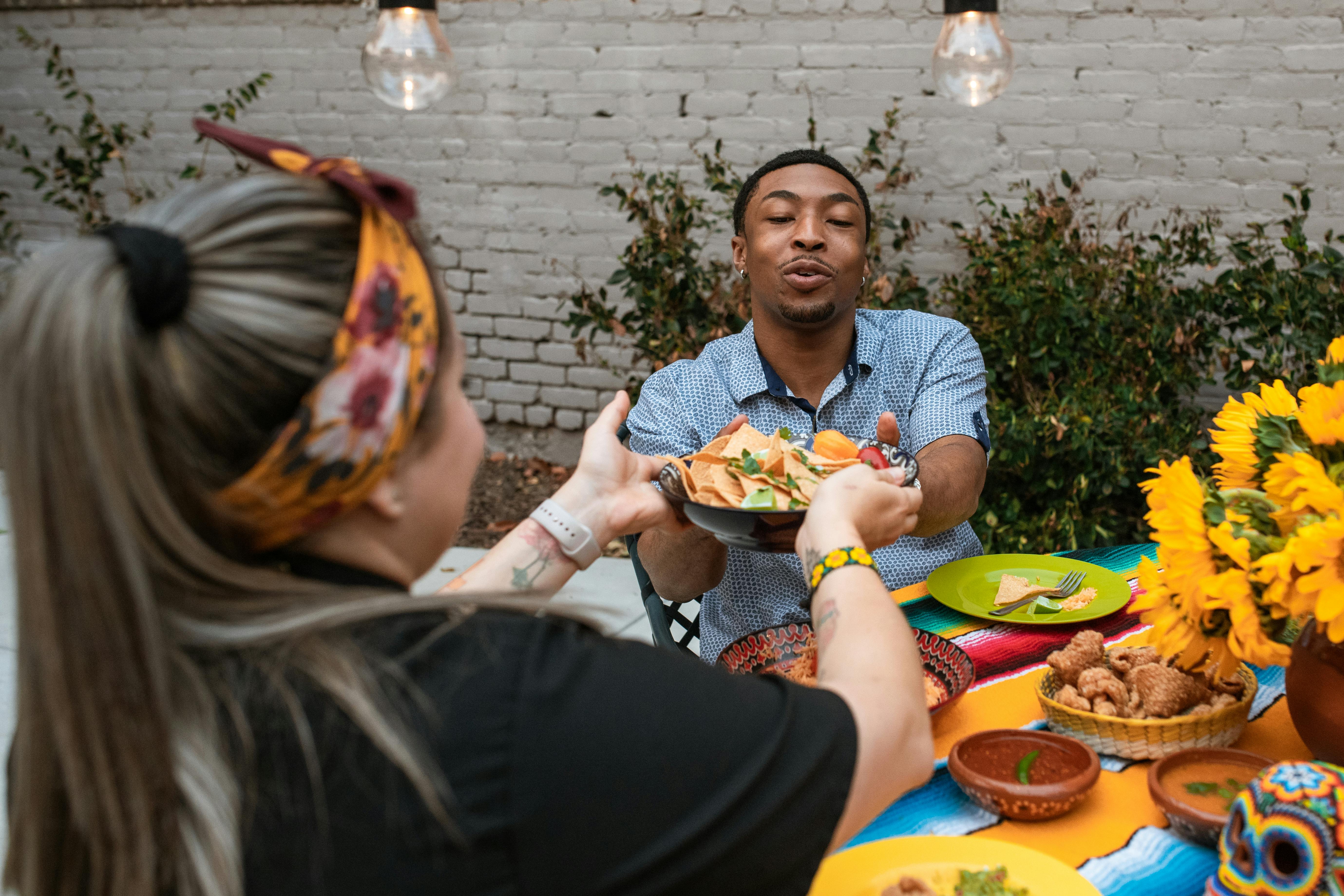 A People Eating while Talking Together · Free Stock Photo