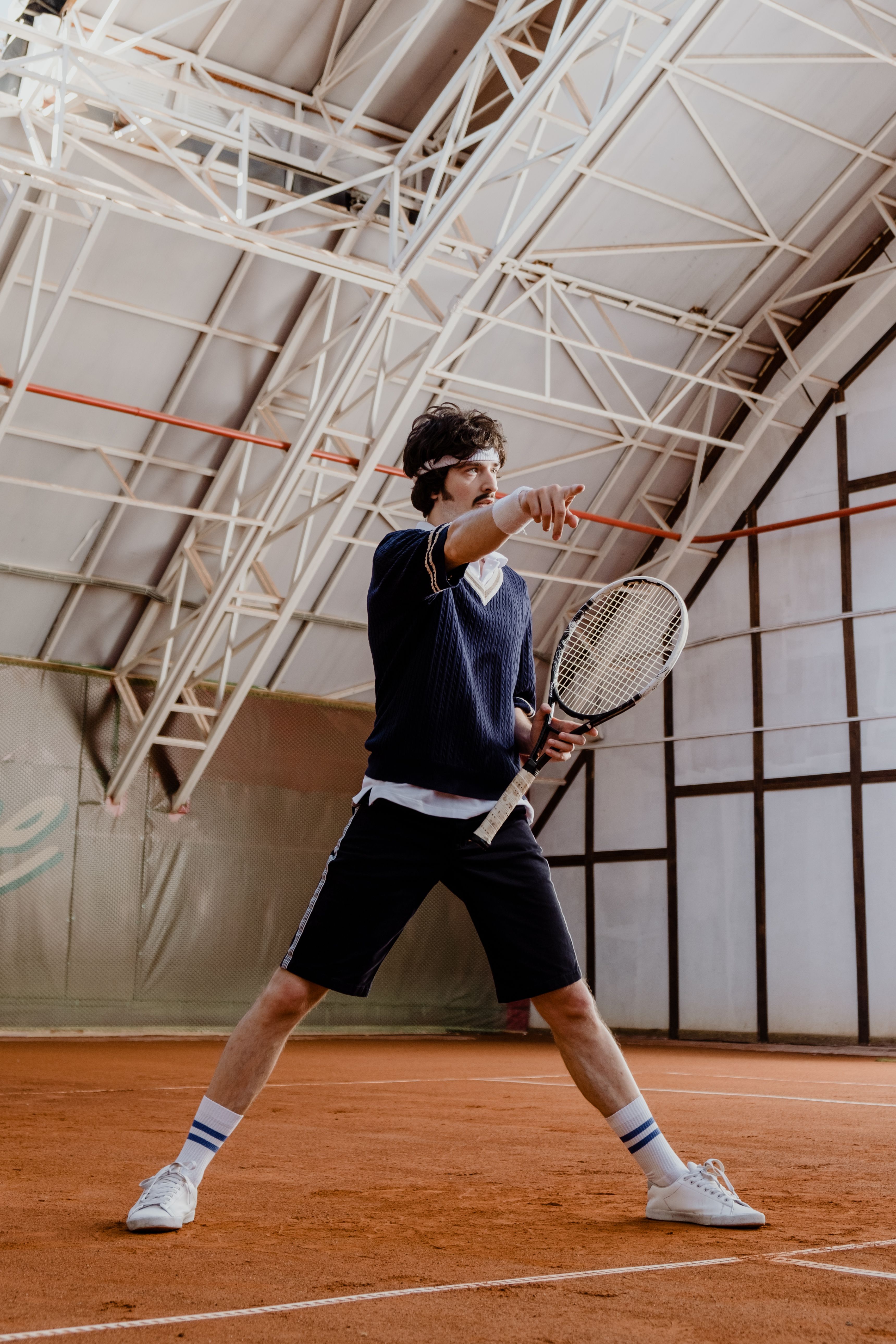 A Tennis Player Pointing while Holding a Racket · Free Stock Photo