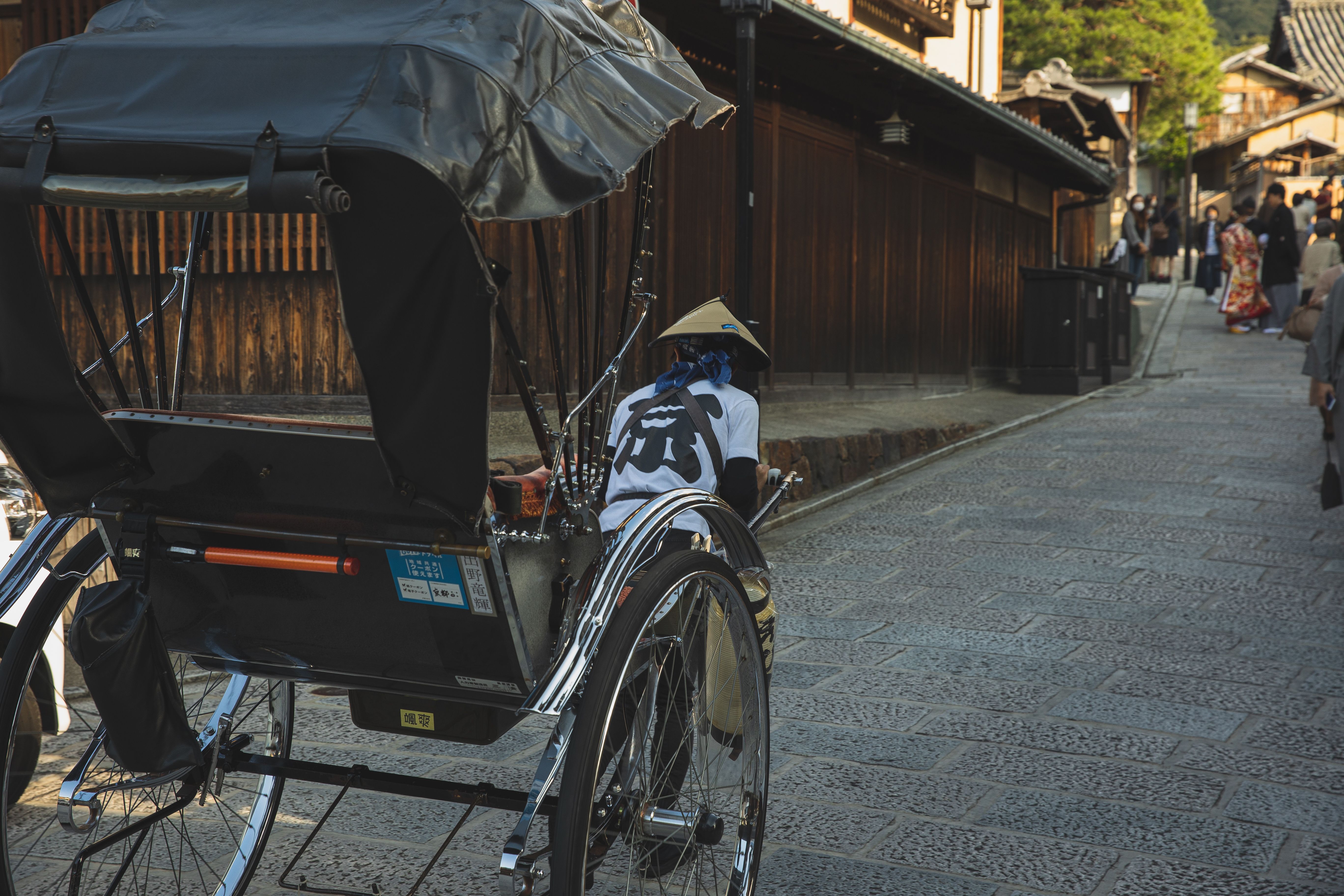 Faceless Asian man pulling carriage on street · Free Stock Photo