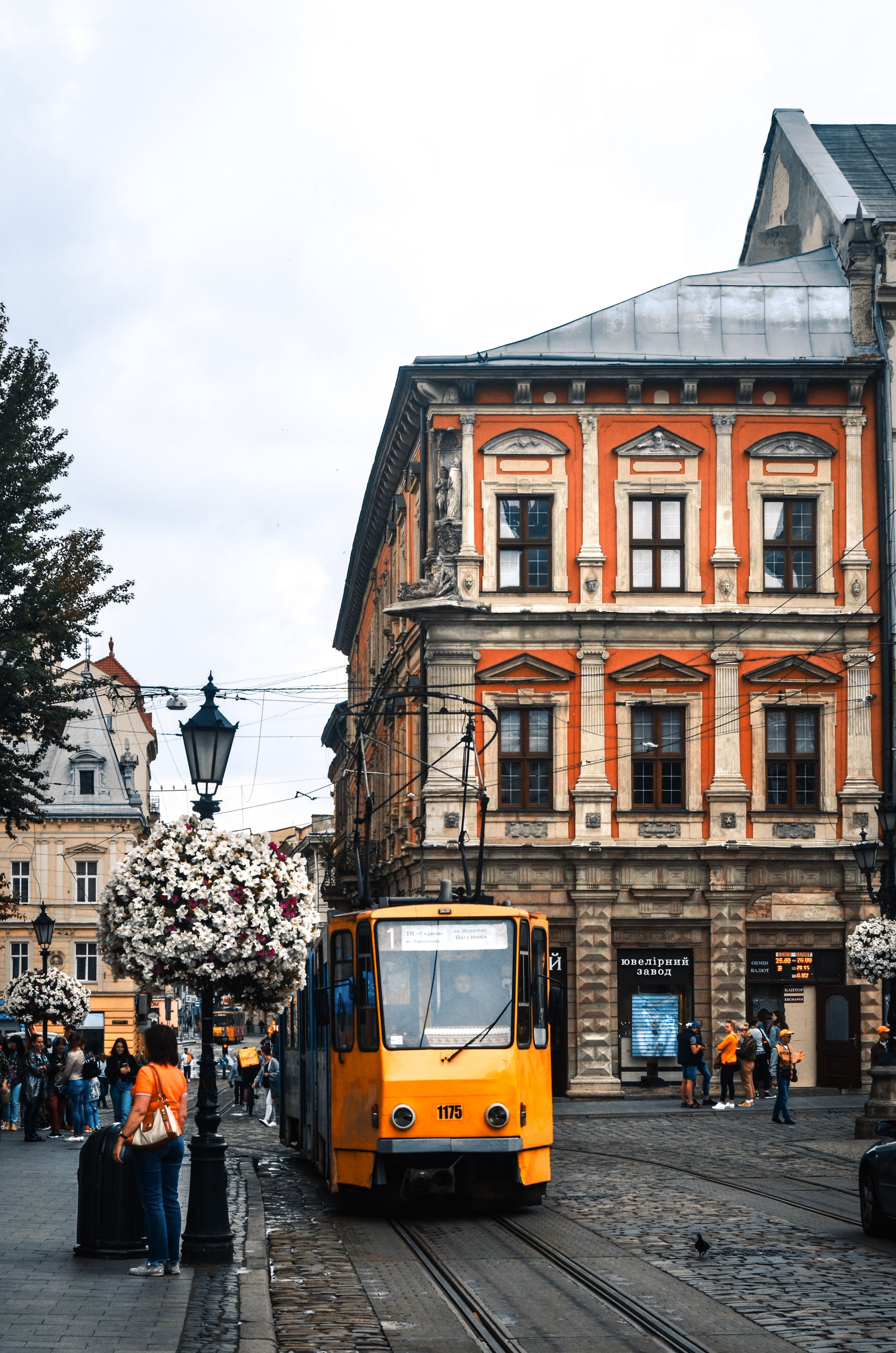 Yellow tram in classic city street · Free Stock Photo