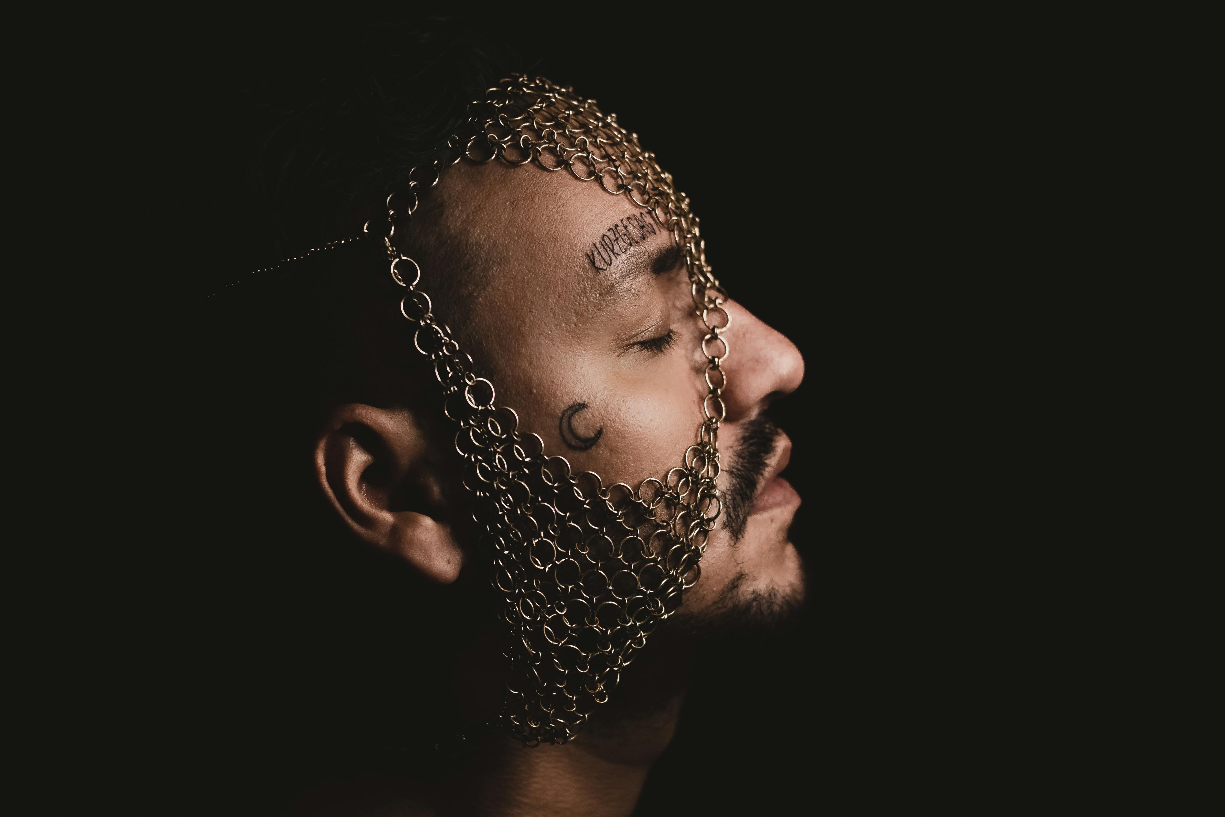 A Man Wearing Silver Chain Link Mask · Free Stock Photo