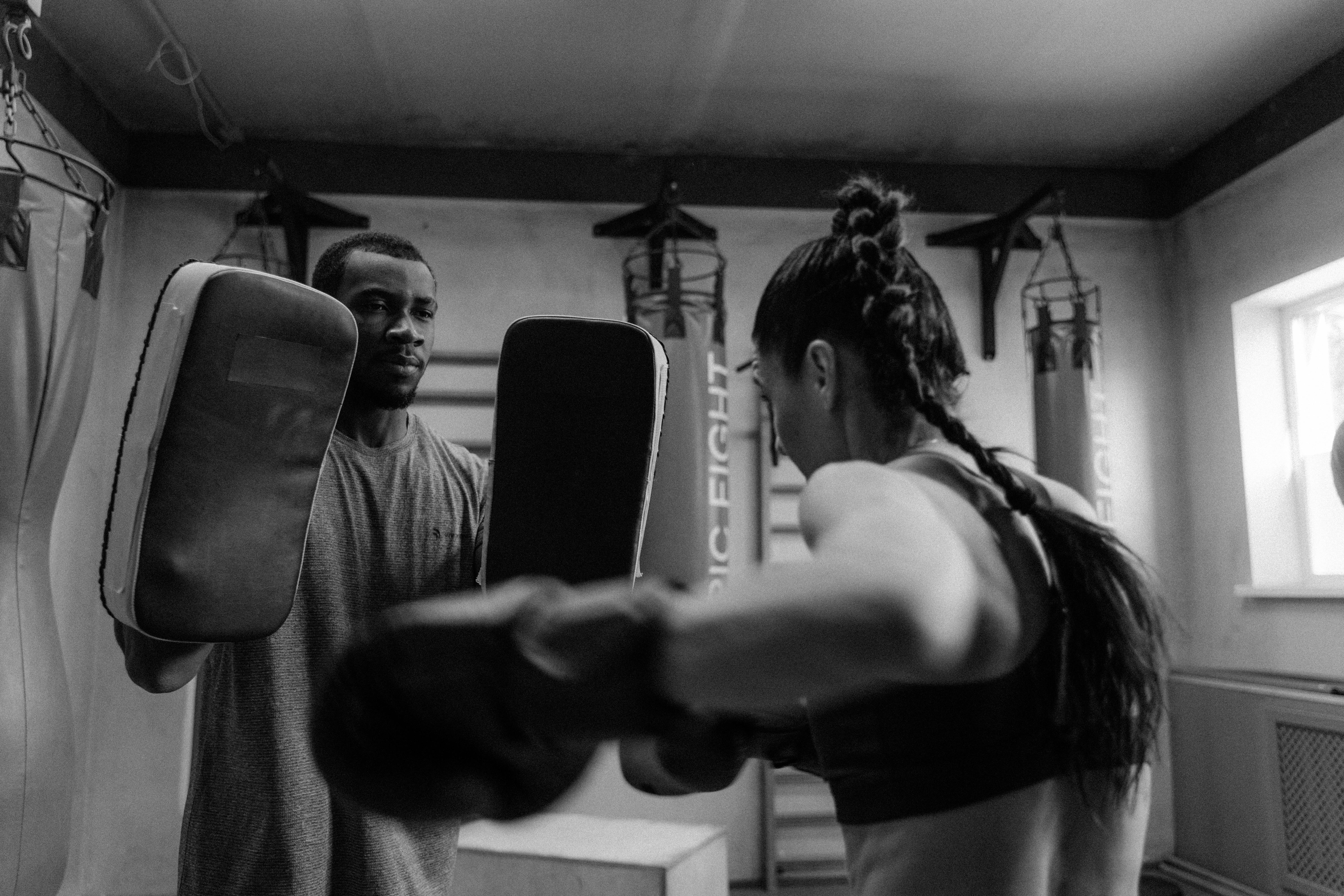 Grayscale Photo of Woman Training inside a Gym · Free Stock Photo