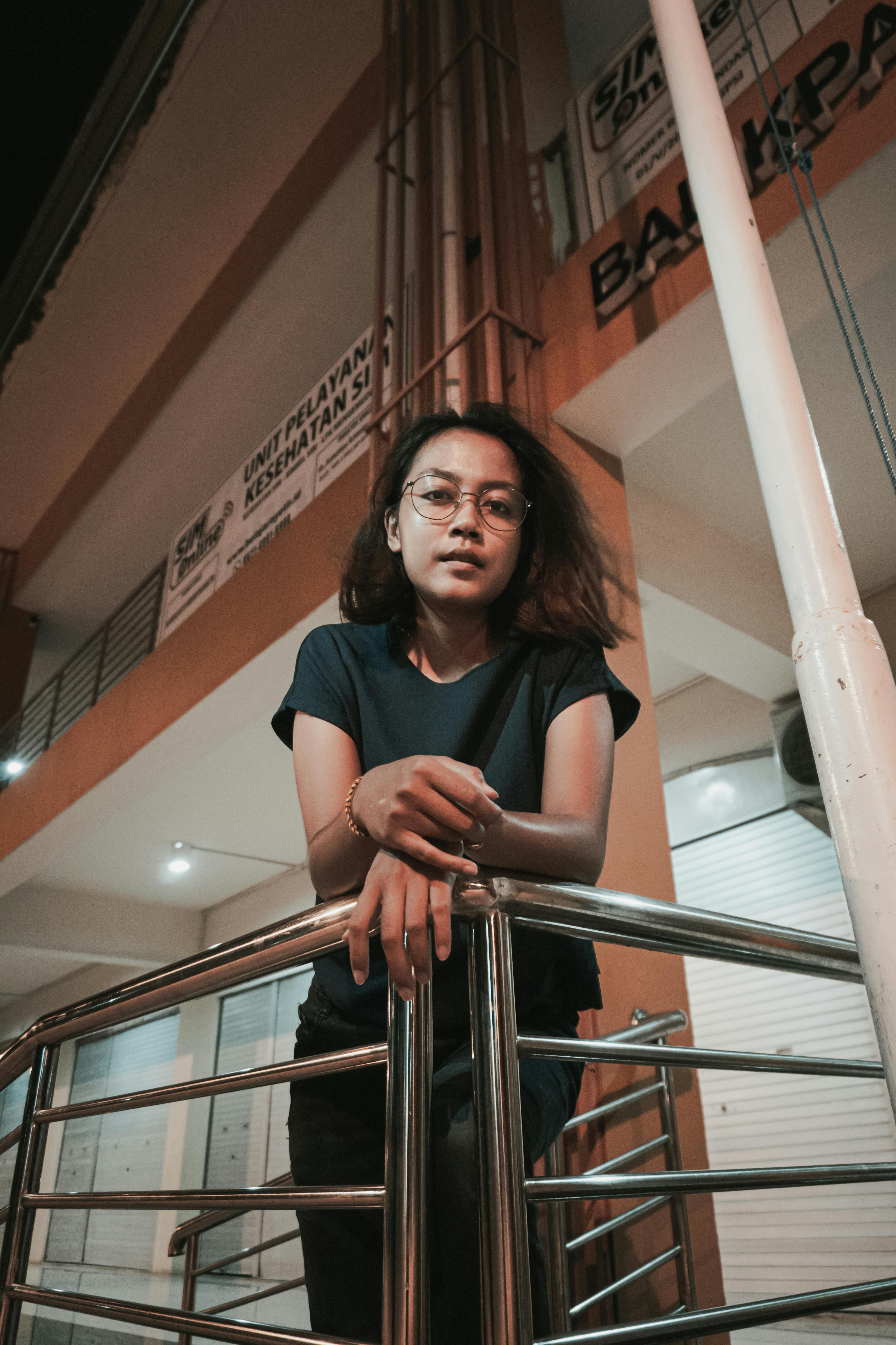 Man Laying on Staircase Railing · Free Stock Photo