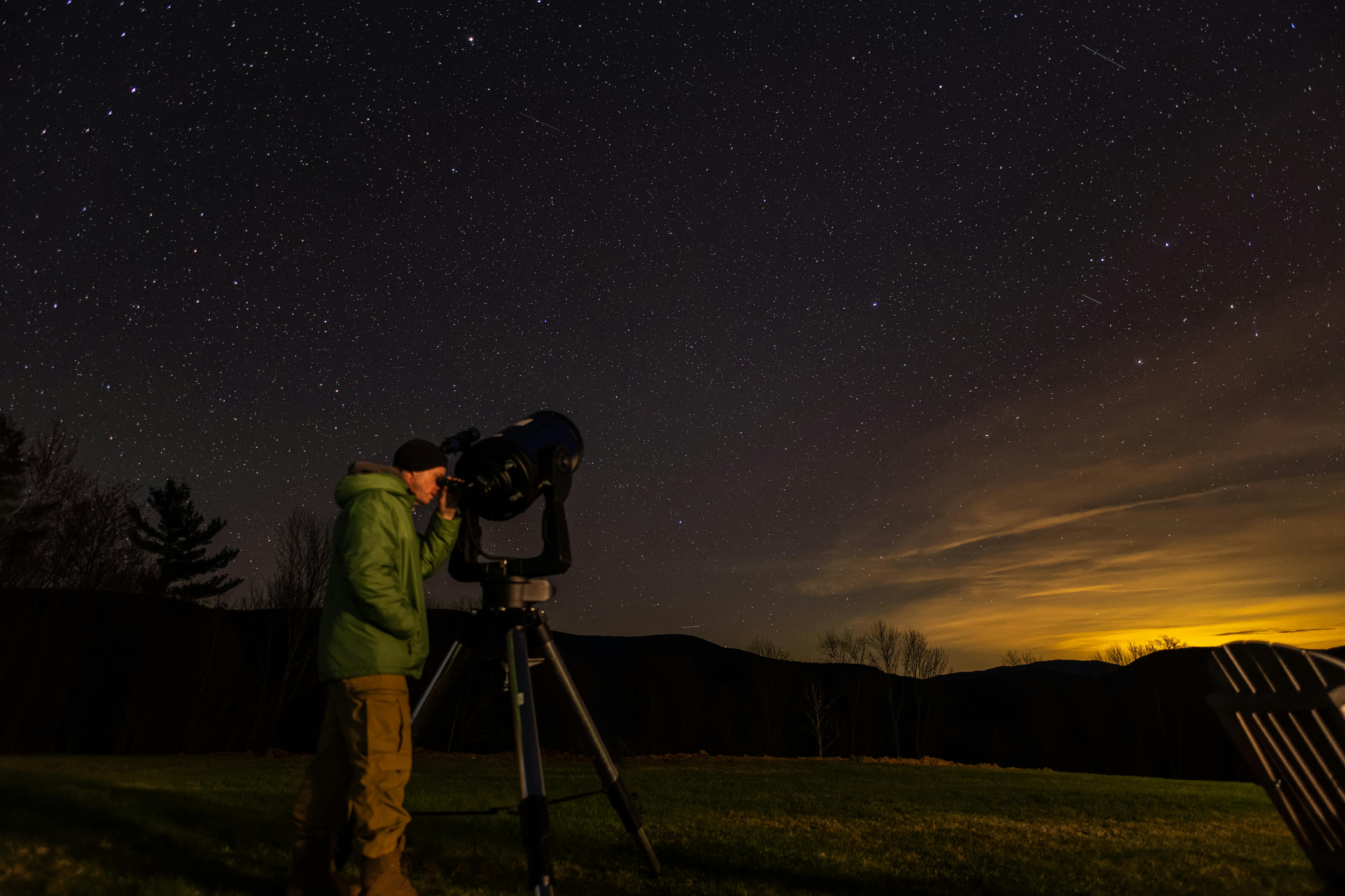 Anonymous male explorer observing stars in mountainous valley in ...