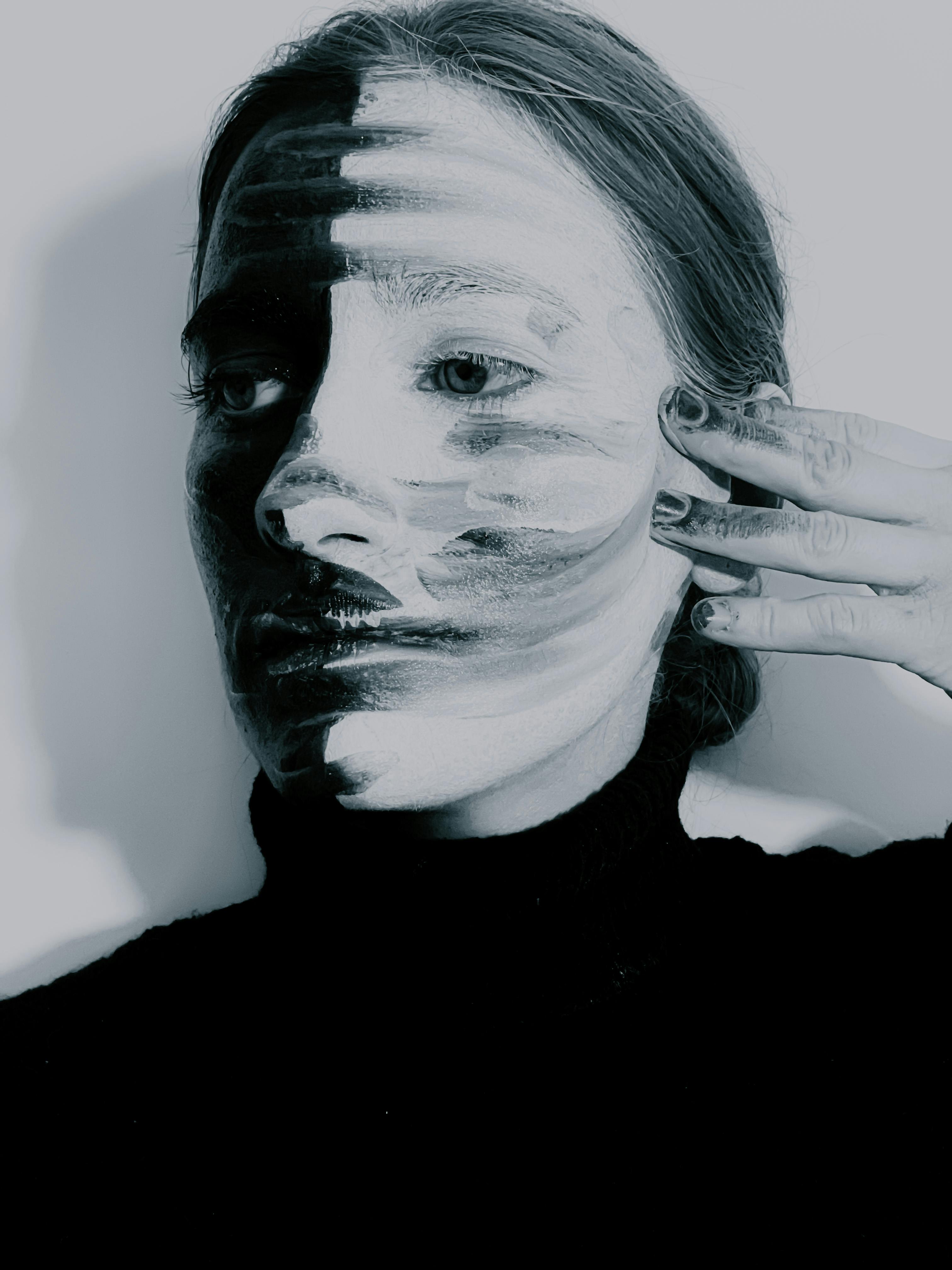 Serious young woman smearing makeup in studio · Free Stock Photo