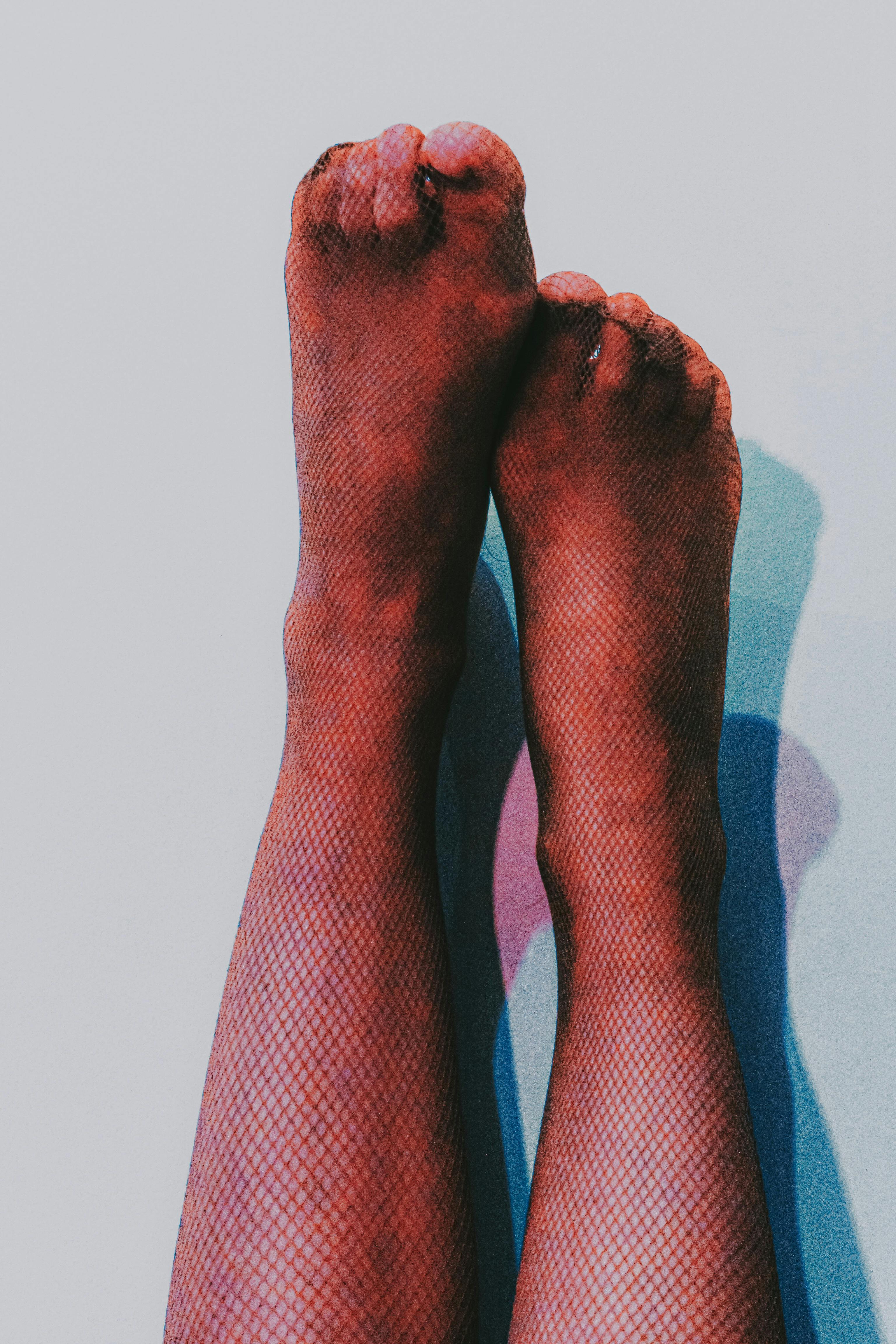 Crop woman legs in fishnet tights · Free Stock Photo