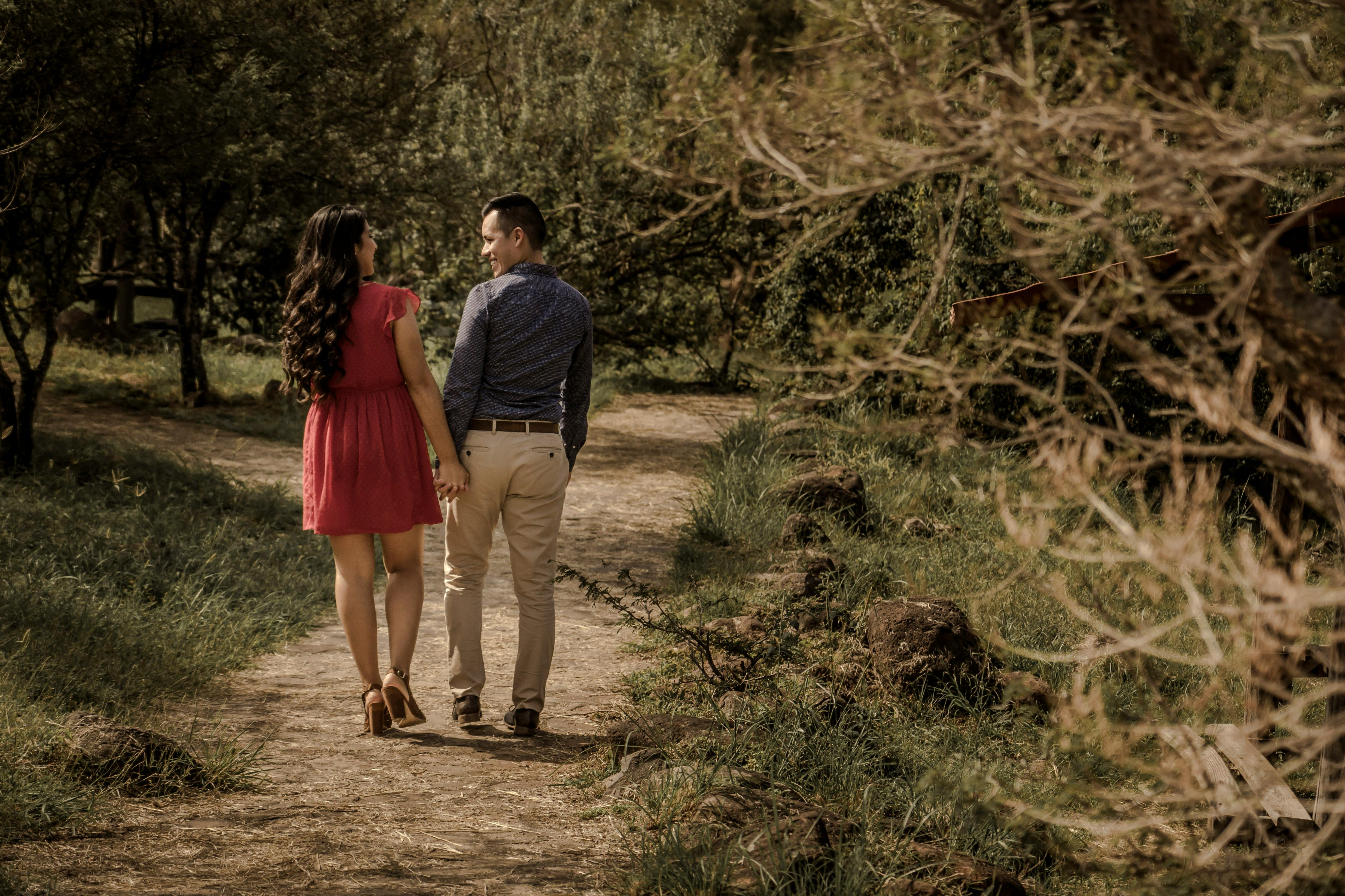 A Couple Walking Side by Side on the Beach Shore · Free Stock Photo