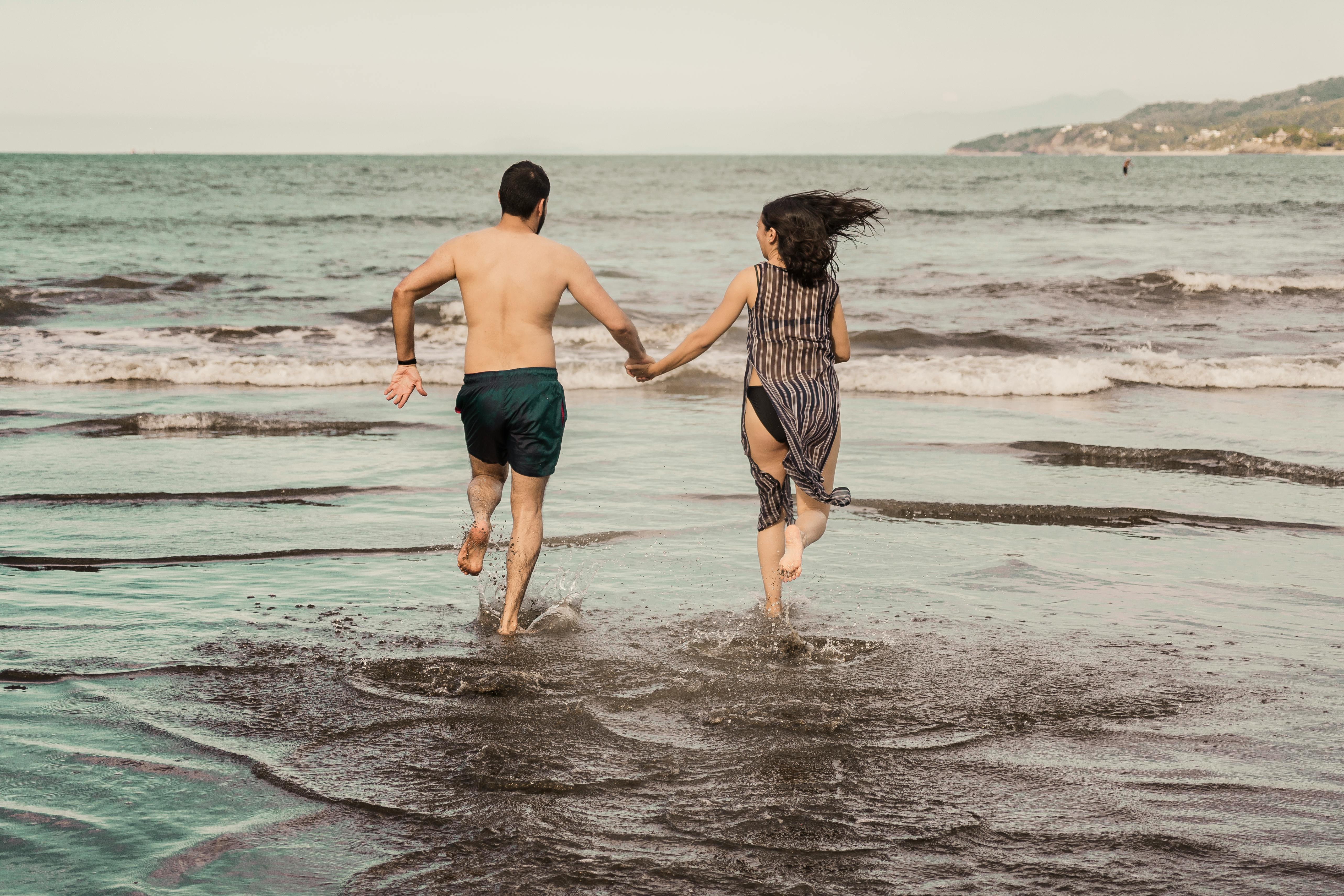 Back View of a Romantic Couple Running in the Middle of the Wheat Field ...
