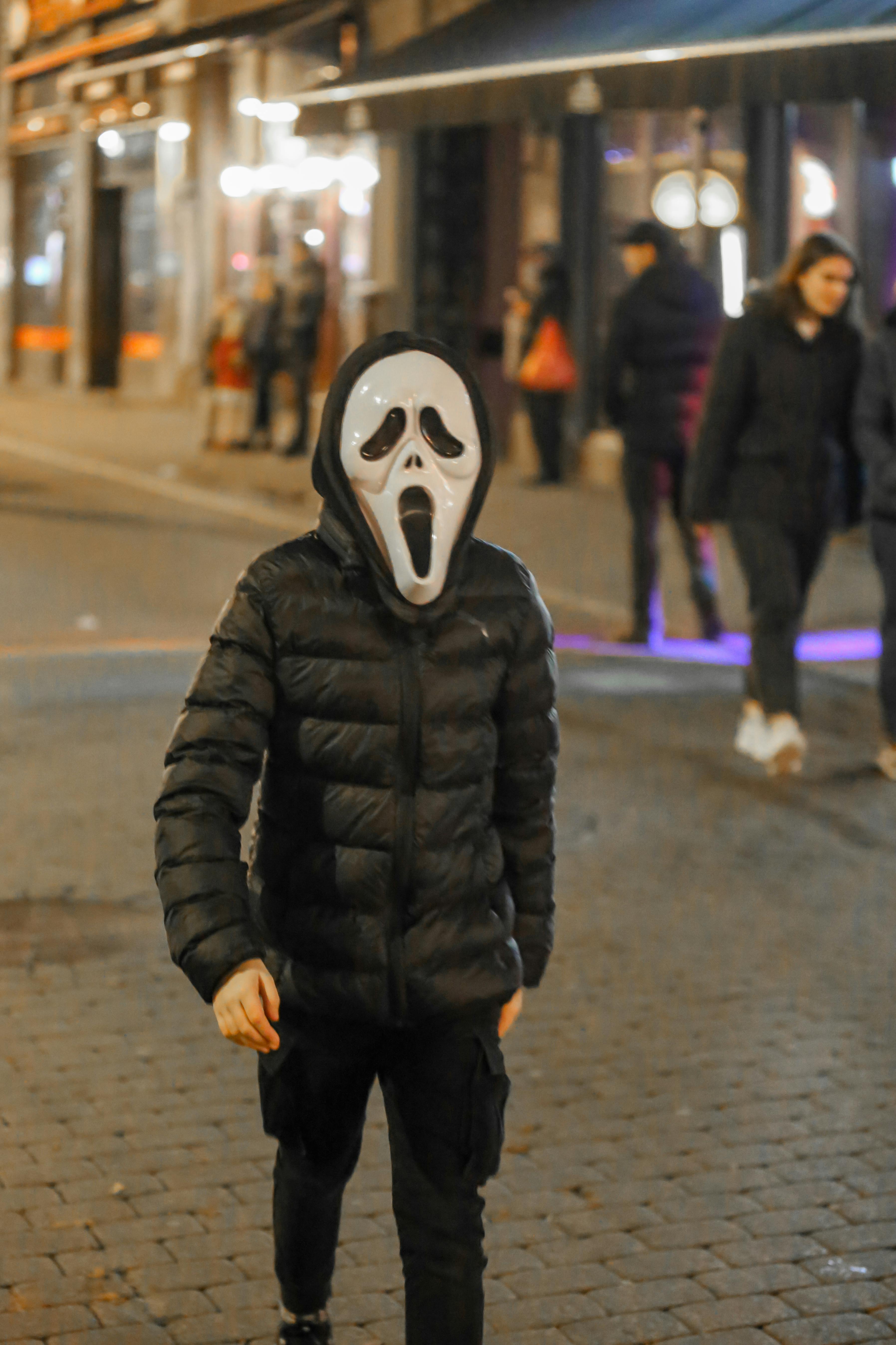A Man in Black Jacket and Black Pants Wearing Scary Mask · Free Stock Photo