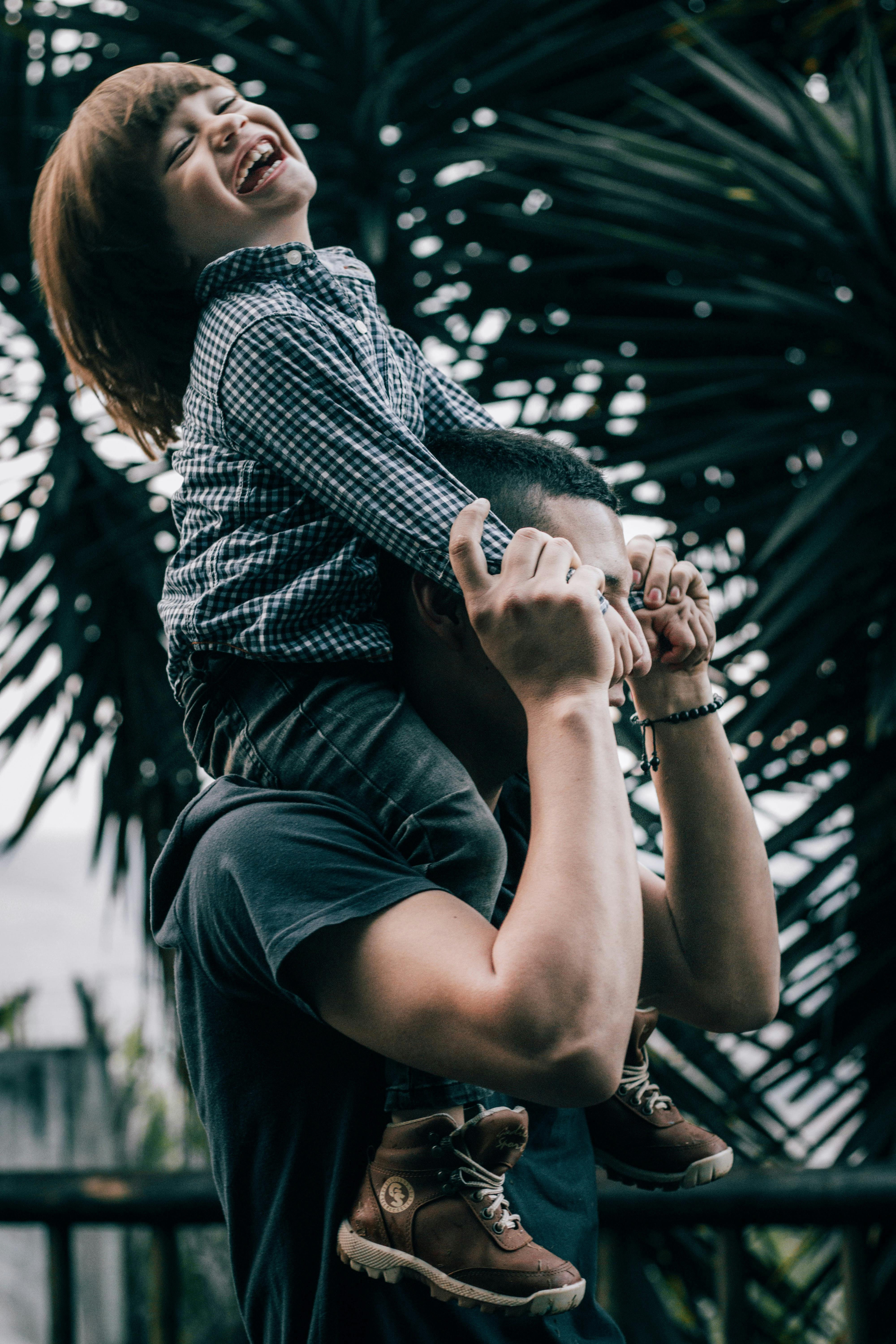A Man Carrying His Child · Free Stock Photo