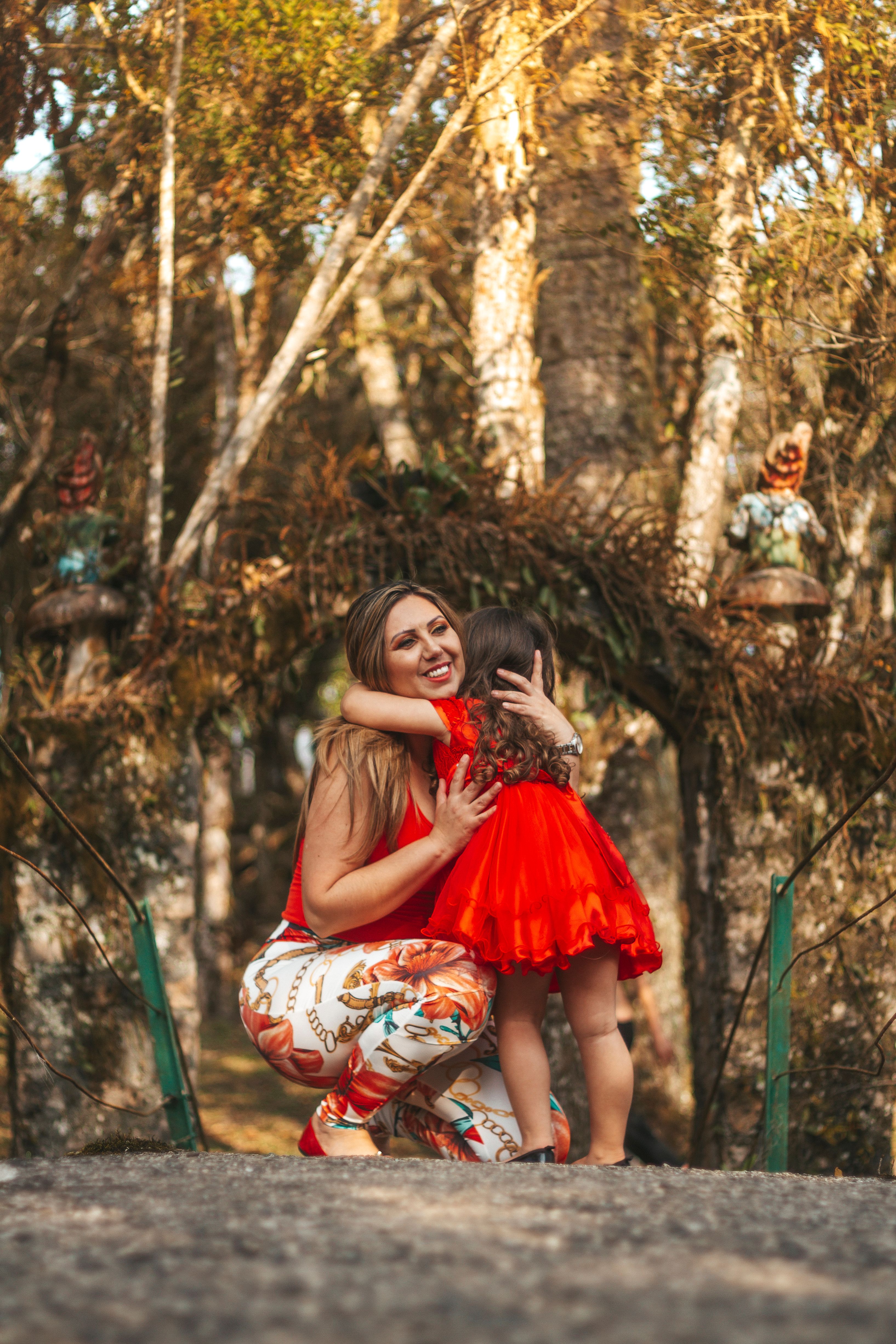 Woman Hugging Girl in Red Dress · Free Stock Photo