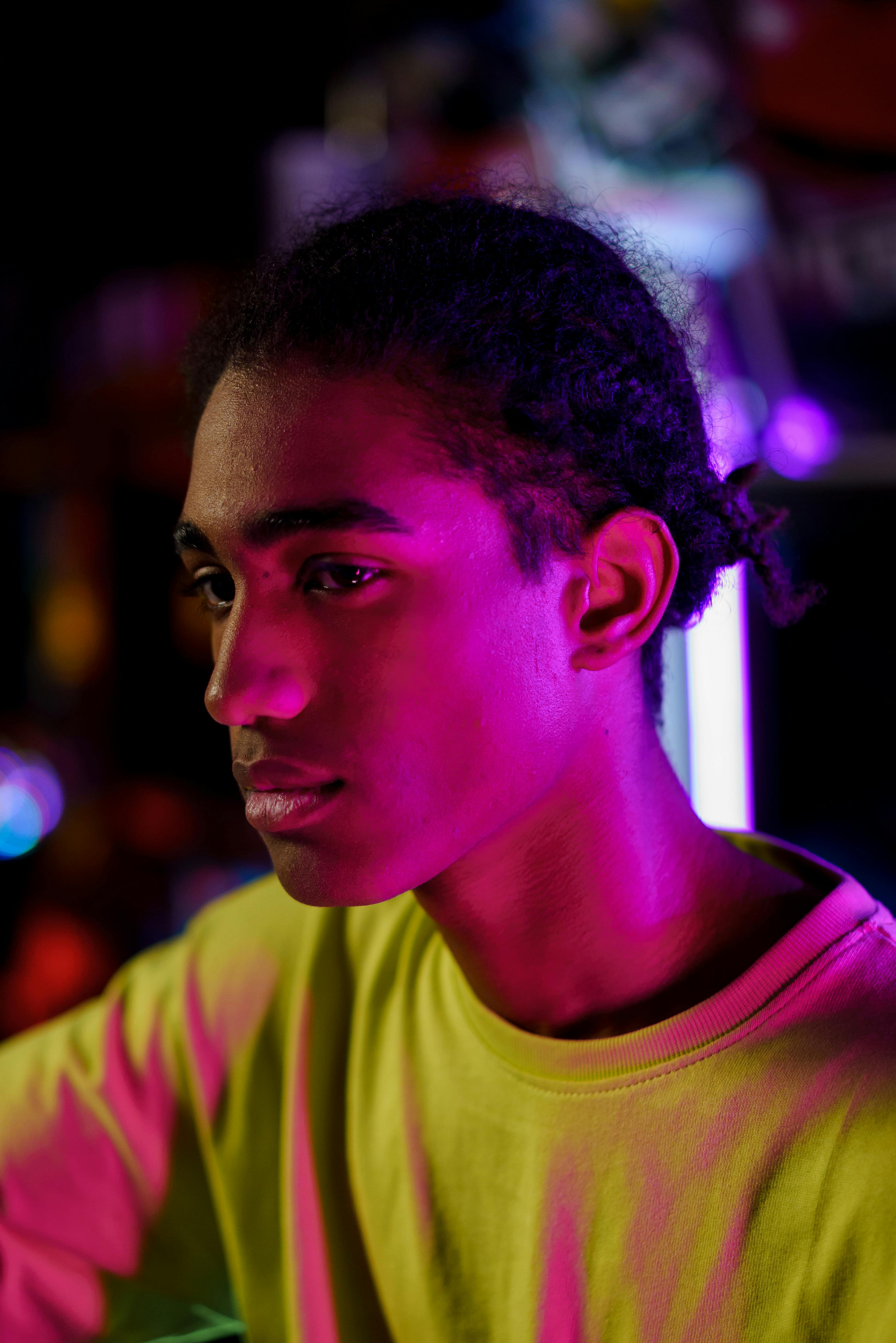 Young Man next to Red Neon Sign · Free Stock Photo