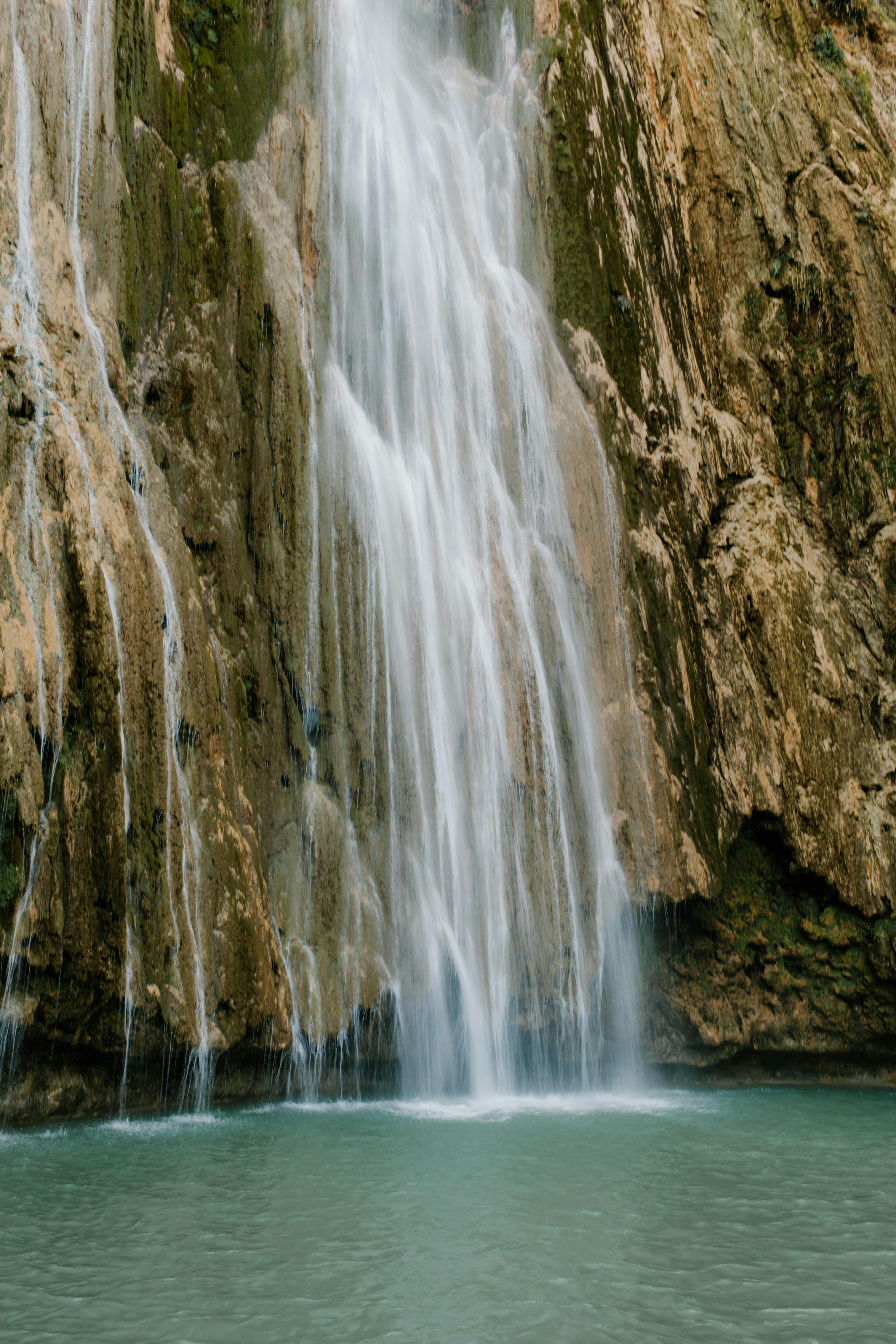 A Rock Formation with Cascade of Waterfalls · Free Stock Photo