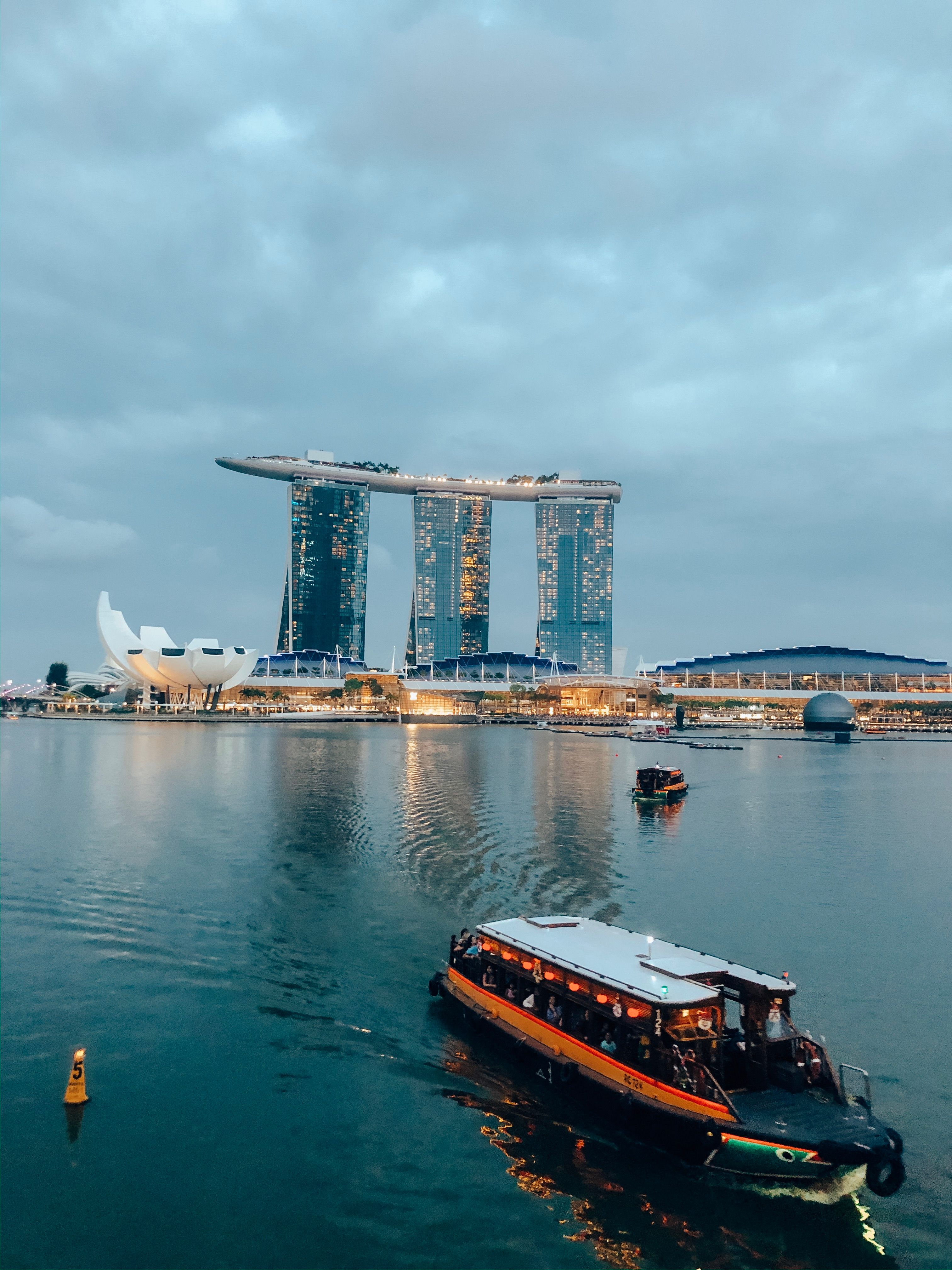 Modern Waterfront Hotel at Dusk · Free Stock Photo