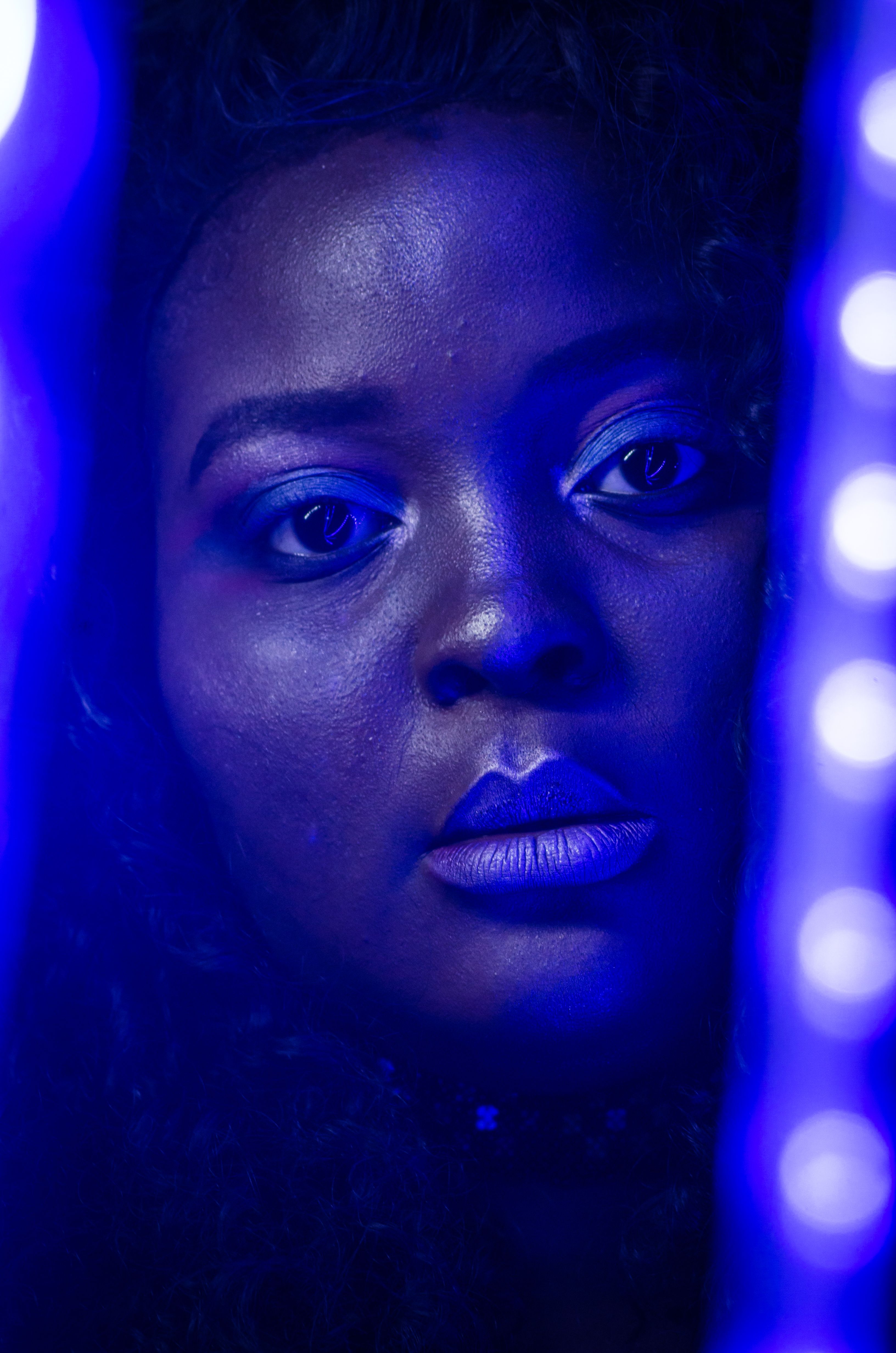 A Woman's Face beside Purple Light · Free Stock Photo
