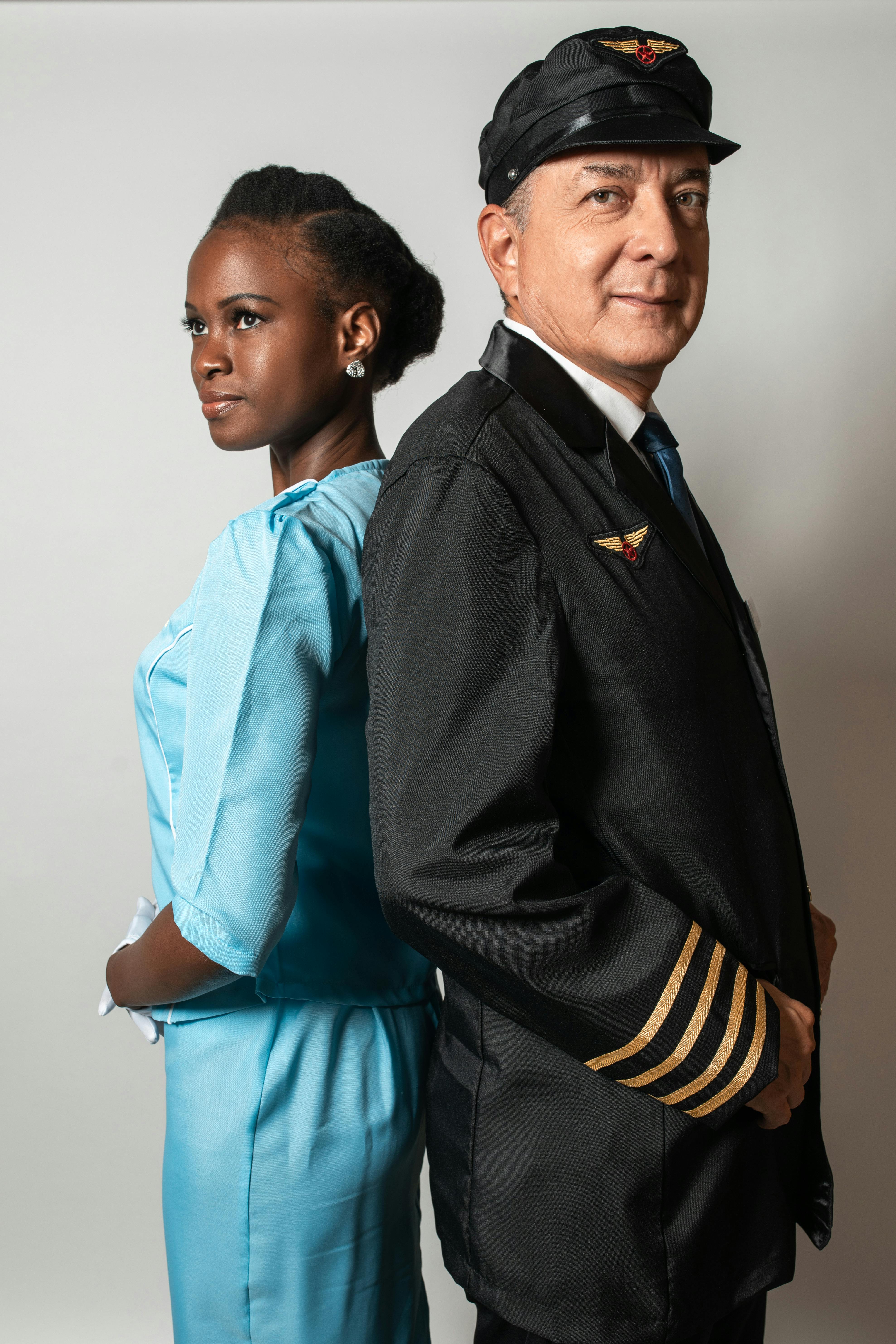 Close-up Photo of a Pilot beside a Flight Attendant · Free Stock Photo
