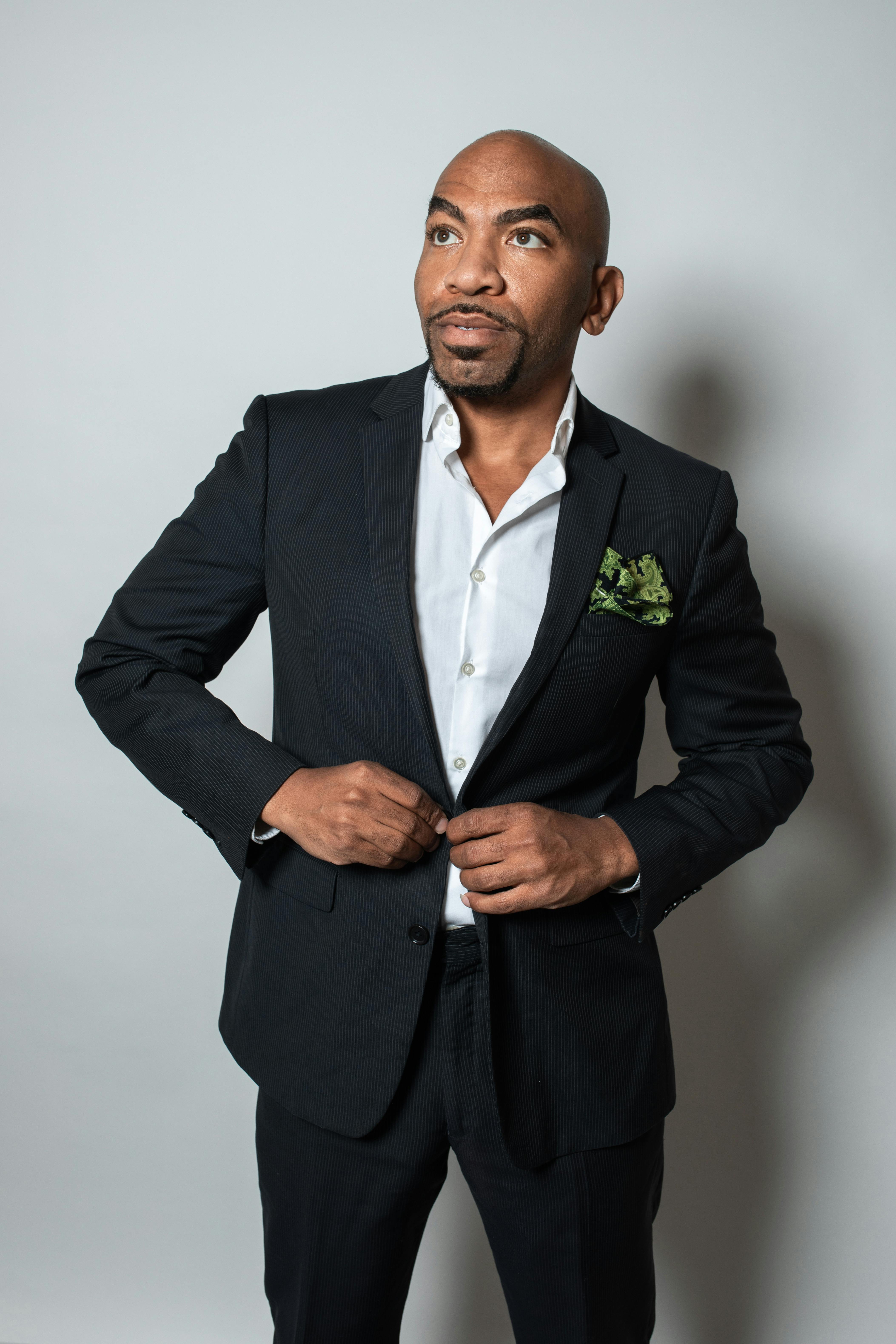 Man Buttoning His Black Suit Jacket · Free Stock Photo