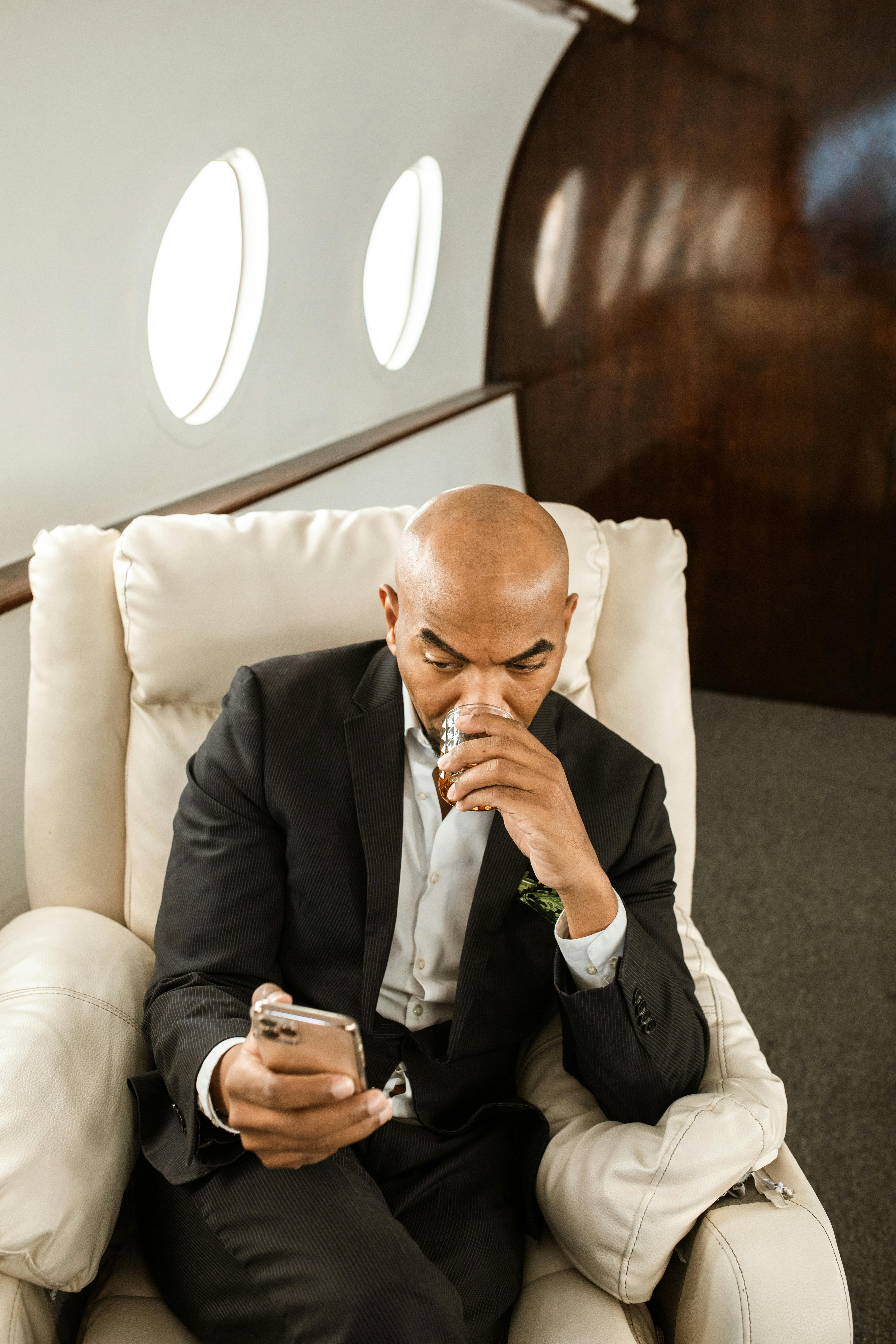 Man in Black Suit on a Private Jet · Free Stock Photo