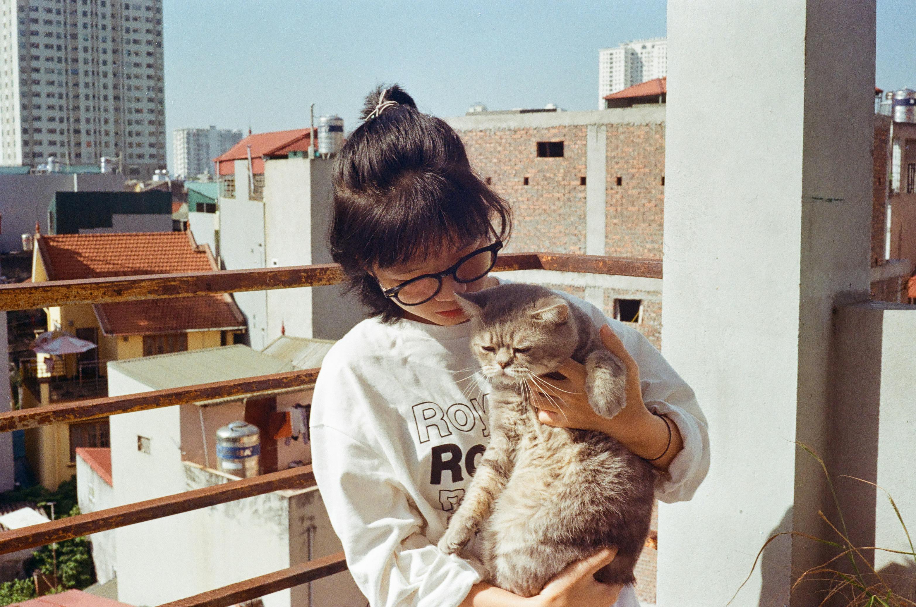 Young Girl Carrying a Cat · Free Stock Photo