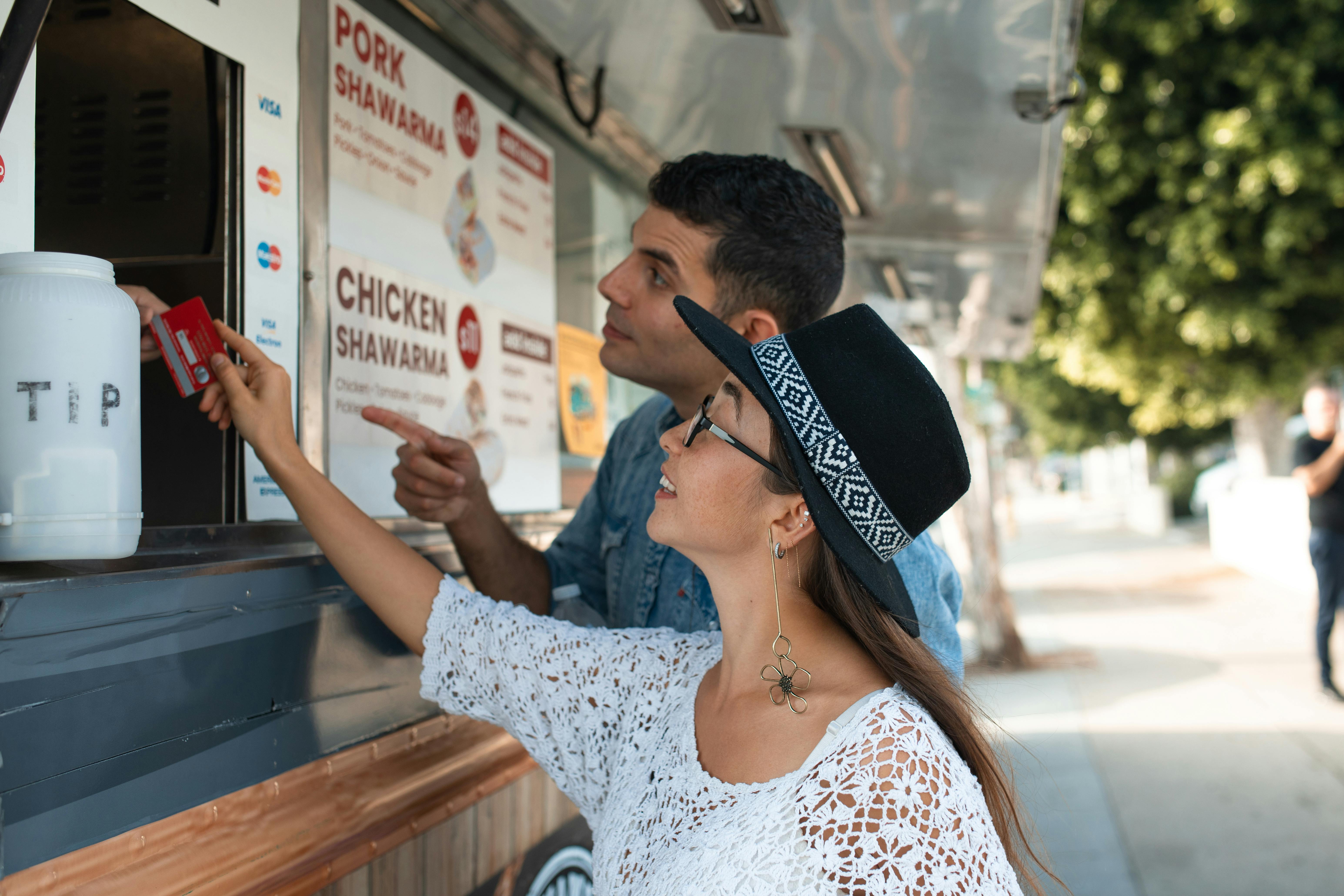Woman receiving a Food Order from a Food Truck · Free Stock Photo