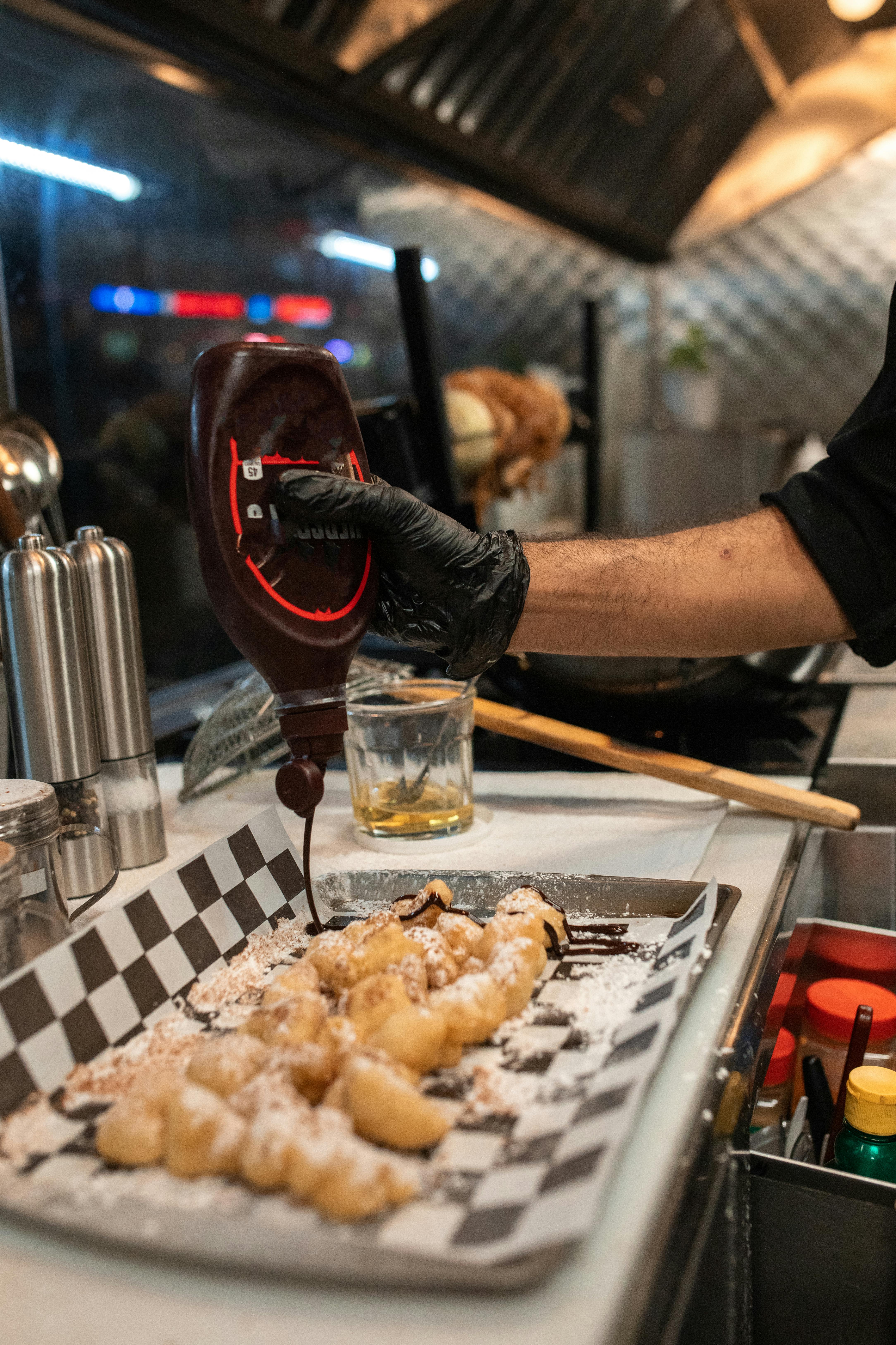 Close-Up Shot of a Person Putting Chocolate Syrup on the Food · Free ...