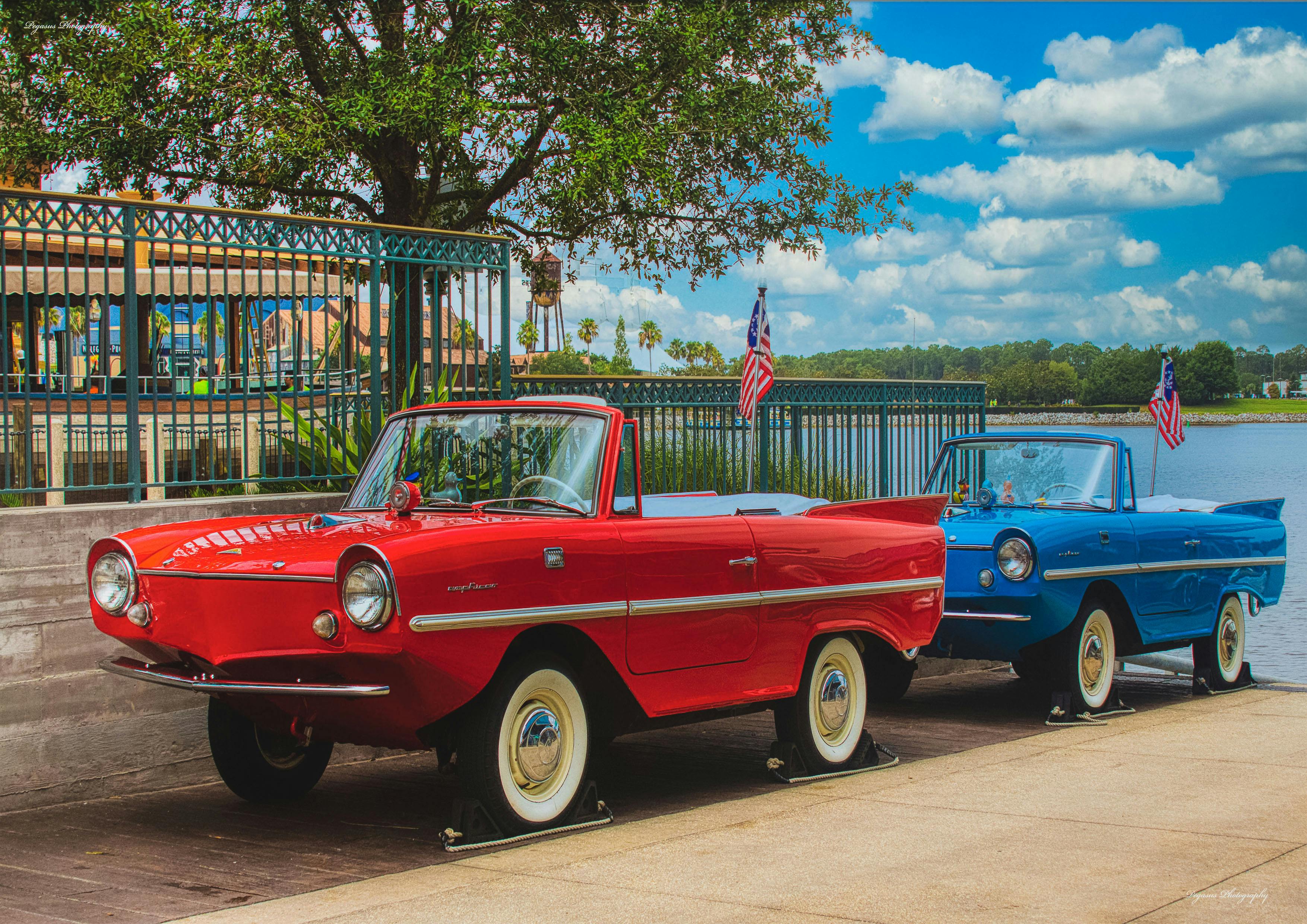 Red and Blue Vintage Cars Parked on Roadside · Free Stock Photo