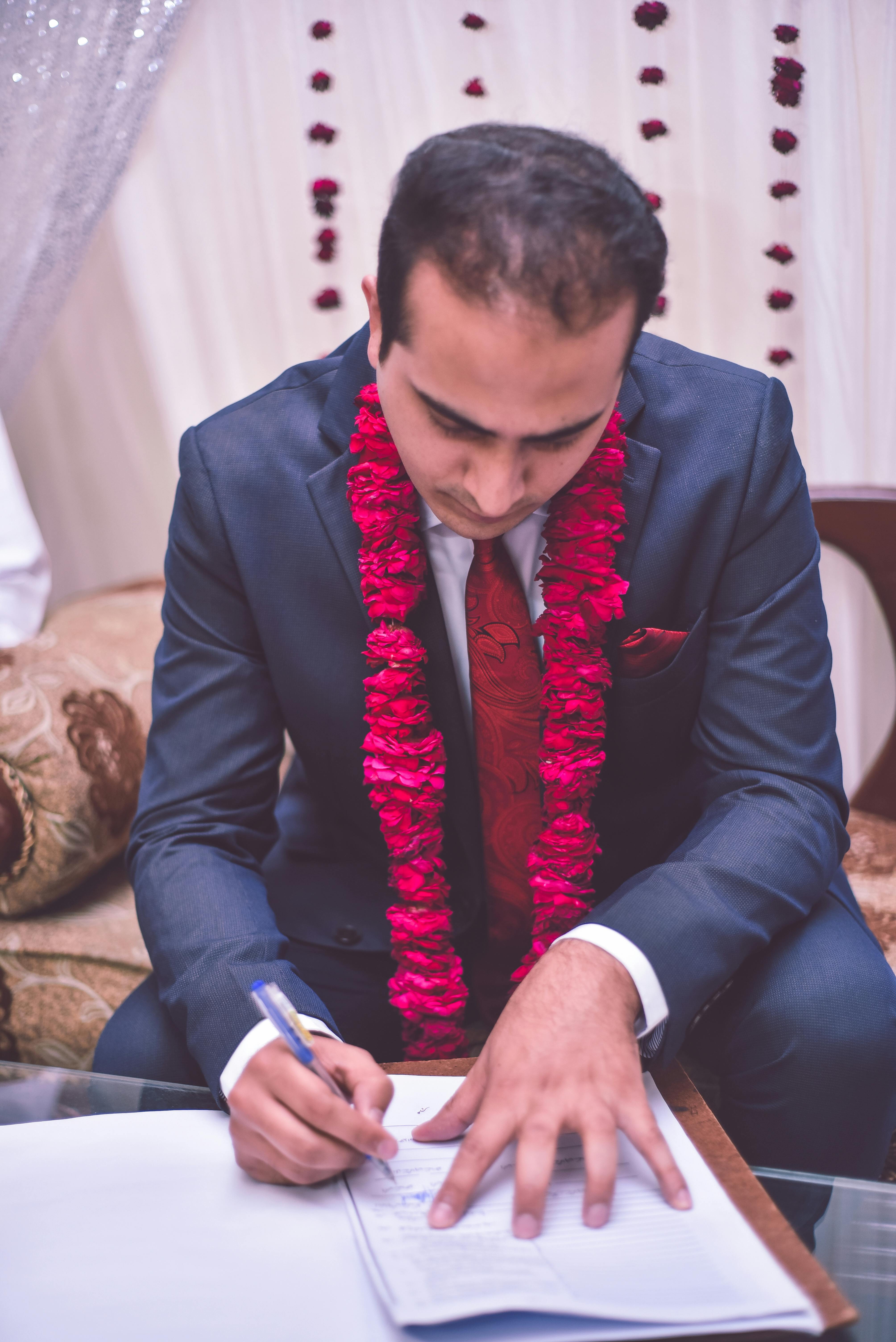 Person Signing on a Paper · Free Stock Photo